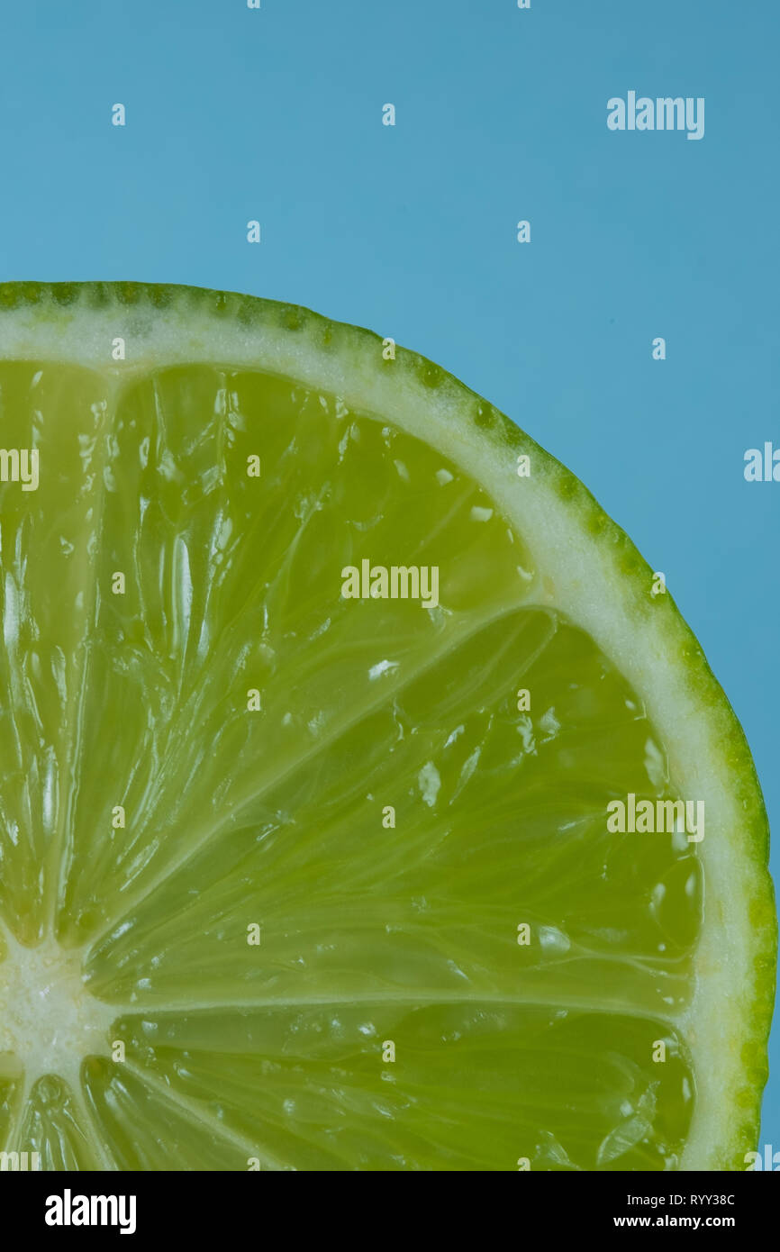 Lime closeup on blue background Stock Photo - Alamy