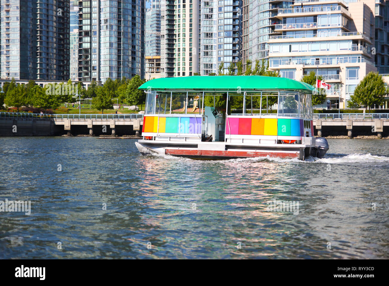 An aquabus or water taxi plying the waters of False Creek toward ...