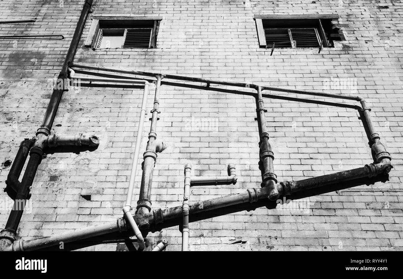 External plumbing in an alleyway Stock Photo - Alamy