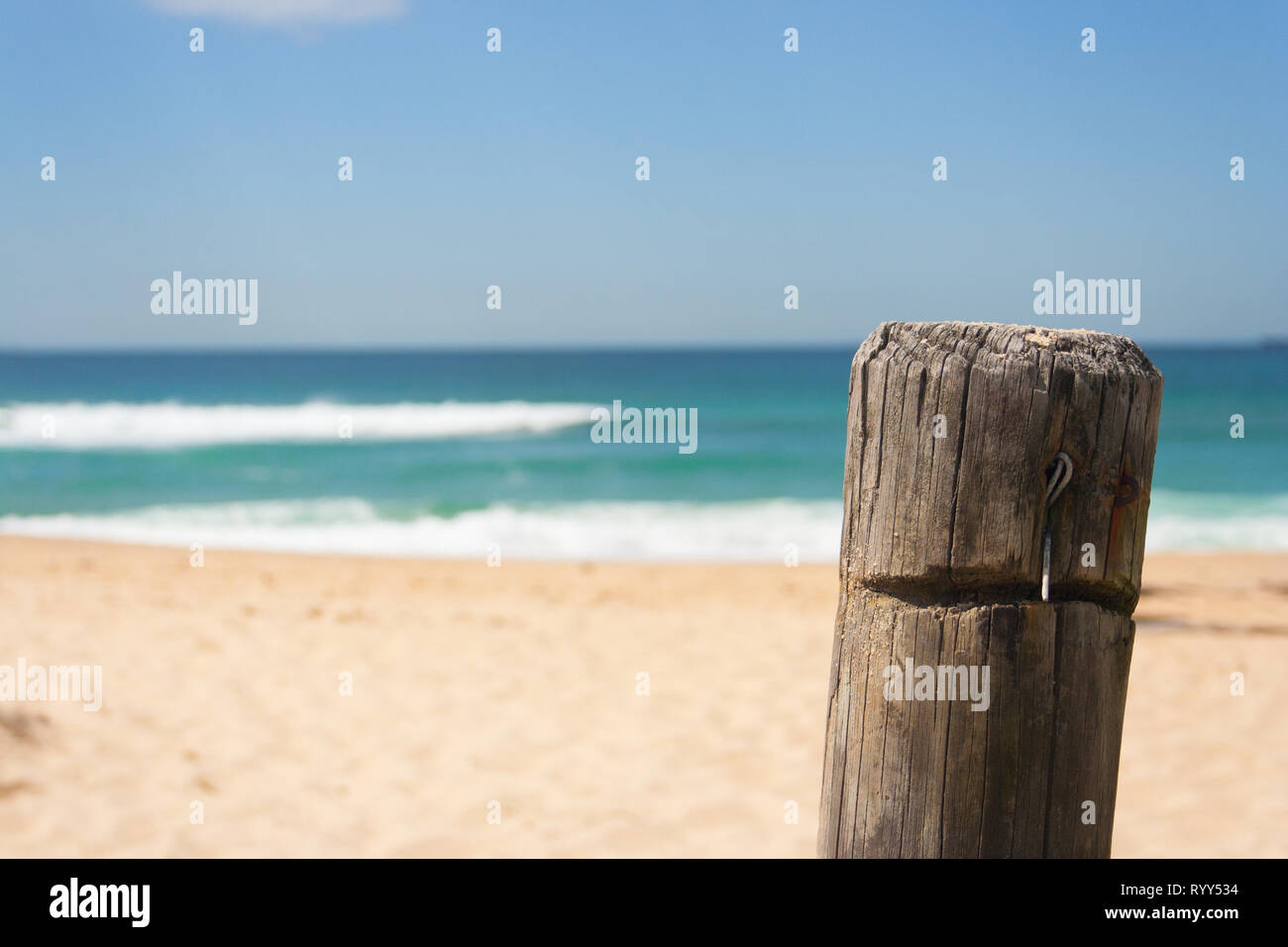 Timber fence post at the beach on a summers day Stock Photo - Alamy