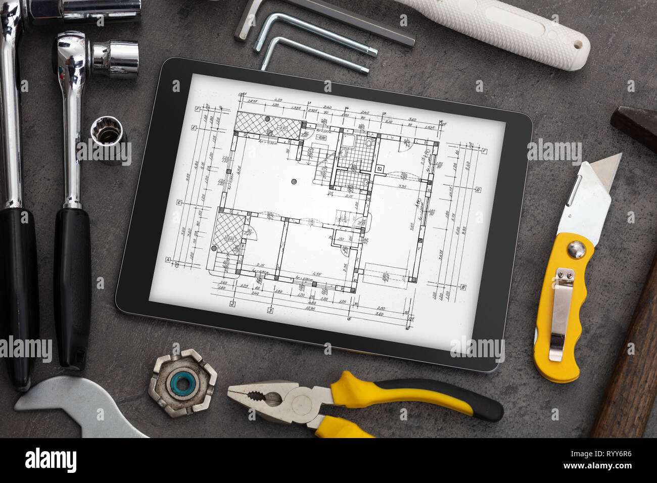 Tablet with construction tools and blueprint concept Stock Photo - Alamy
