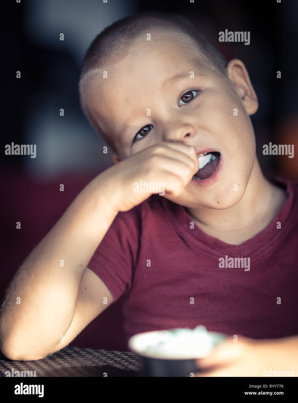 Portrait of a cute boy eating ice cream Stock Photo - Alamy
