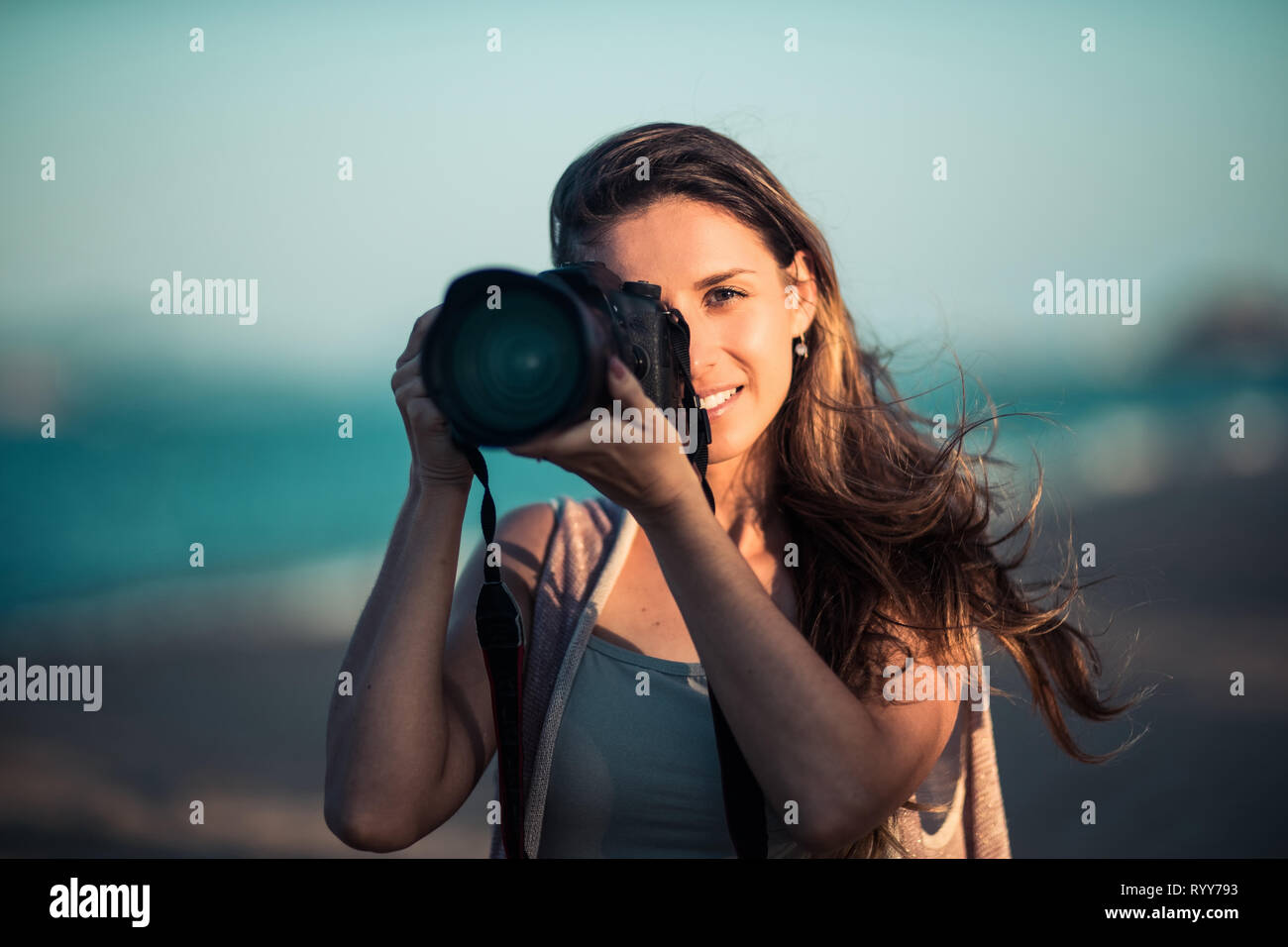 Portrait of a beautiful woman photographer with camera Stock Photo - Alamy