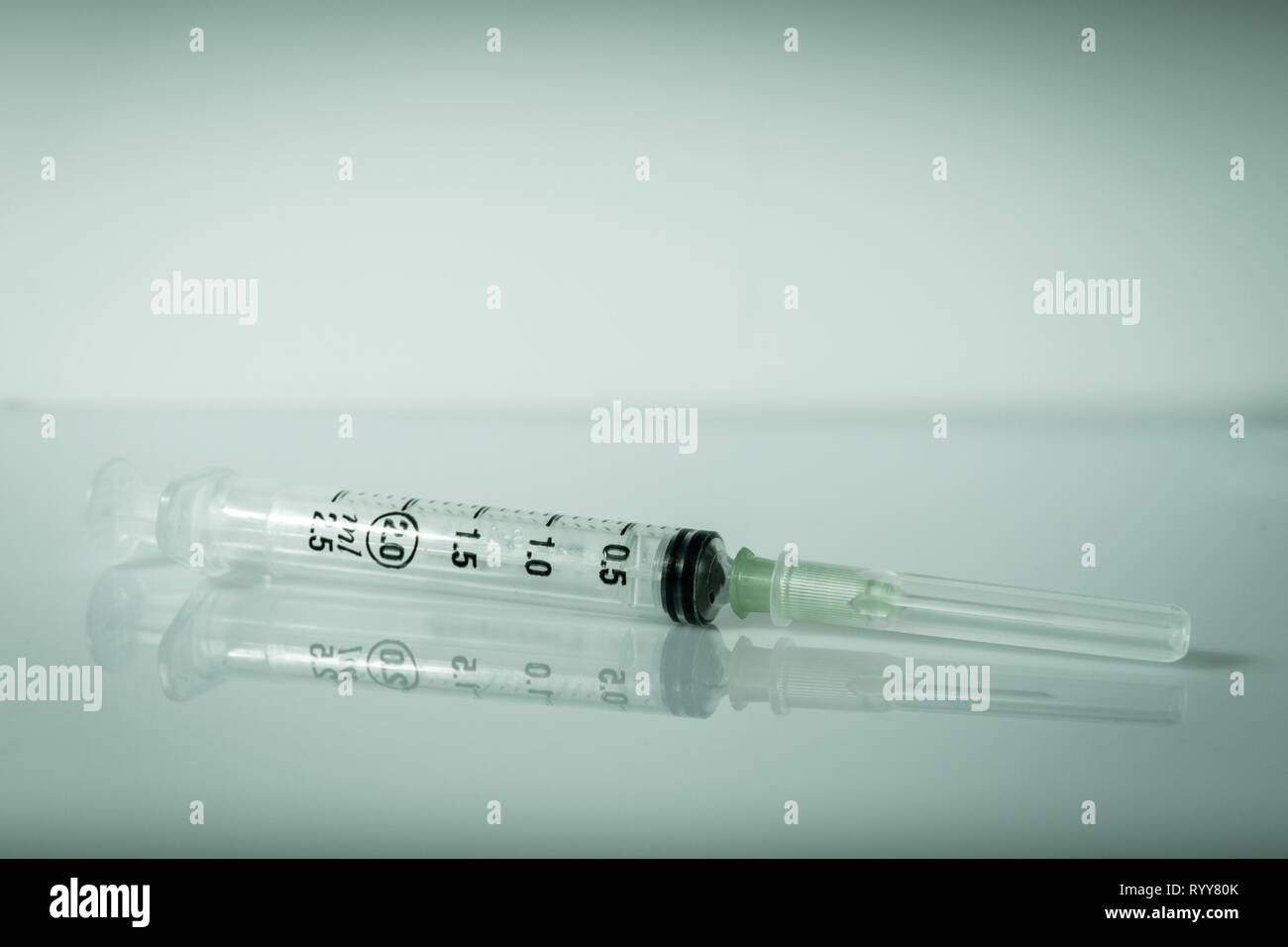 Injection syringe on a clean grey background Stock Photo - Alamy
