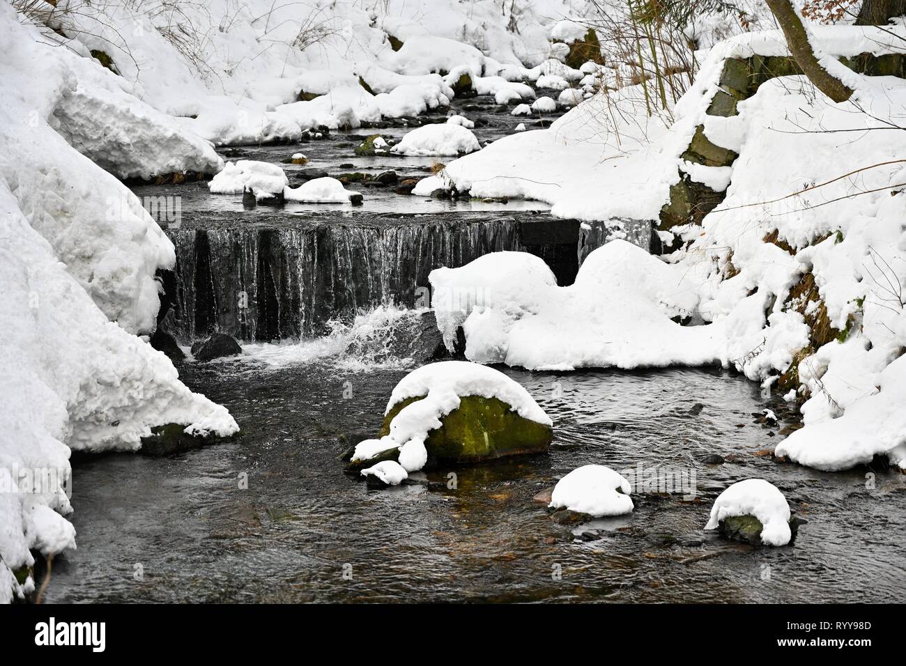 Winter stream with stones and snow. A beautiful winter concept for ...