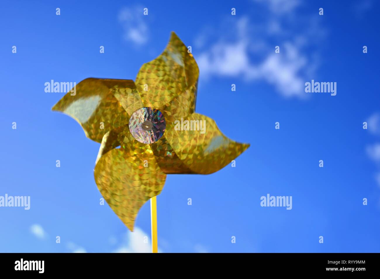 Beautiful yellow wind turbine - vane. Background with blue sky Stock ...