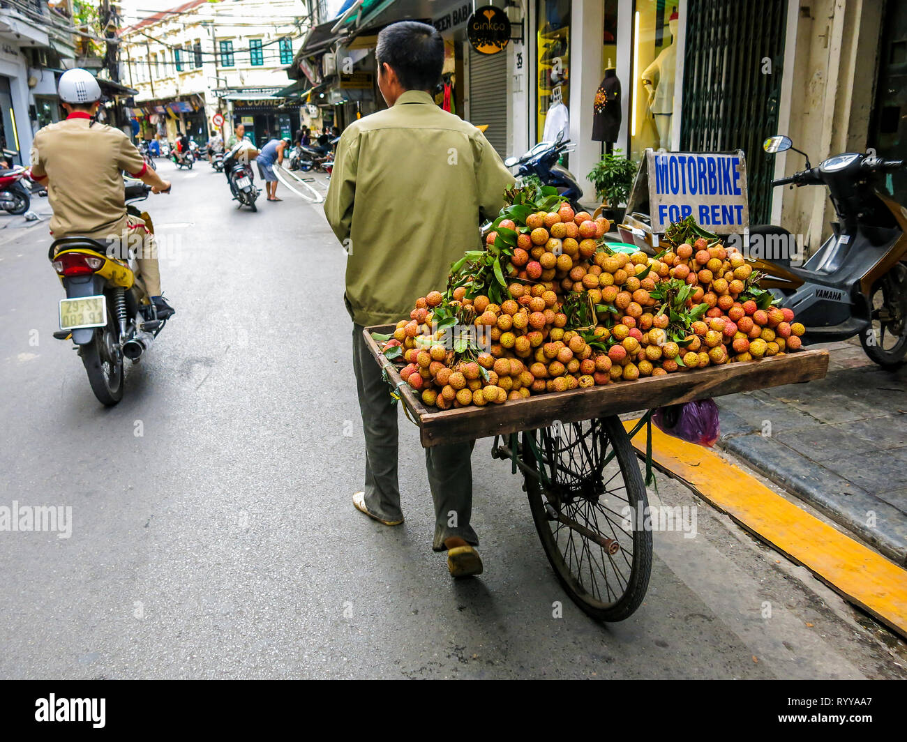Fruit vendor selling gac fruit. Street scene from old town in Hanoi ...