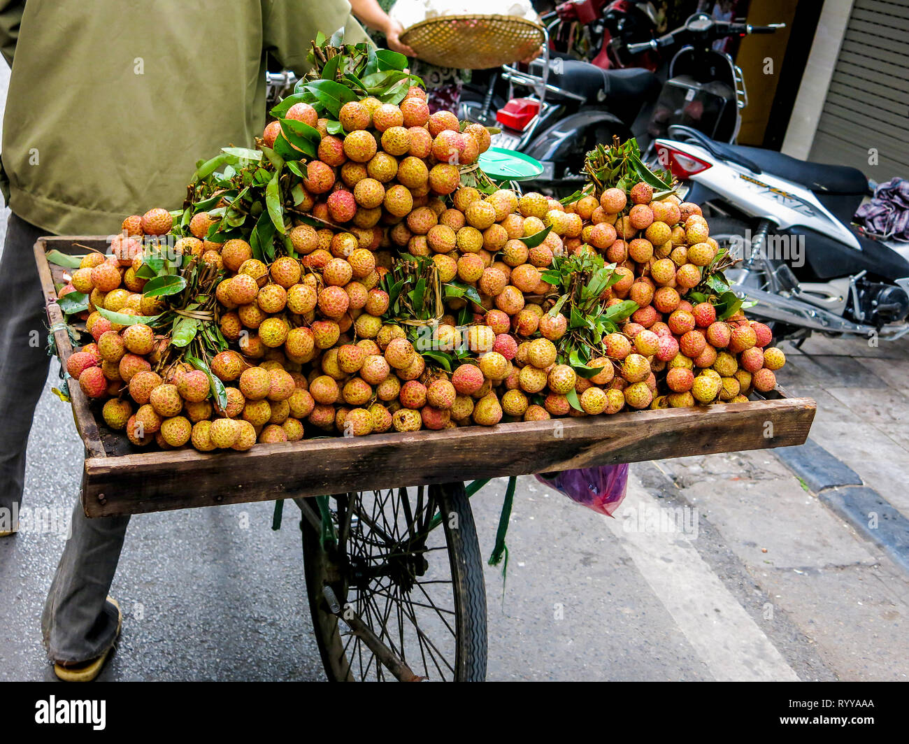 Fruit vendor selling gac fruit. Street scene from old town in Hanoi ...
