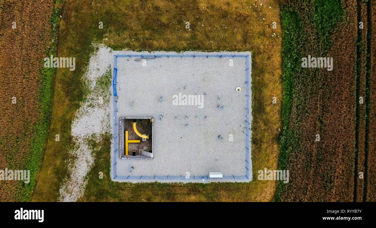 The closer aerial shot of the glass cube in the middle of the field ...