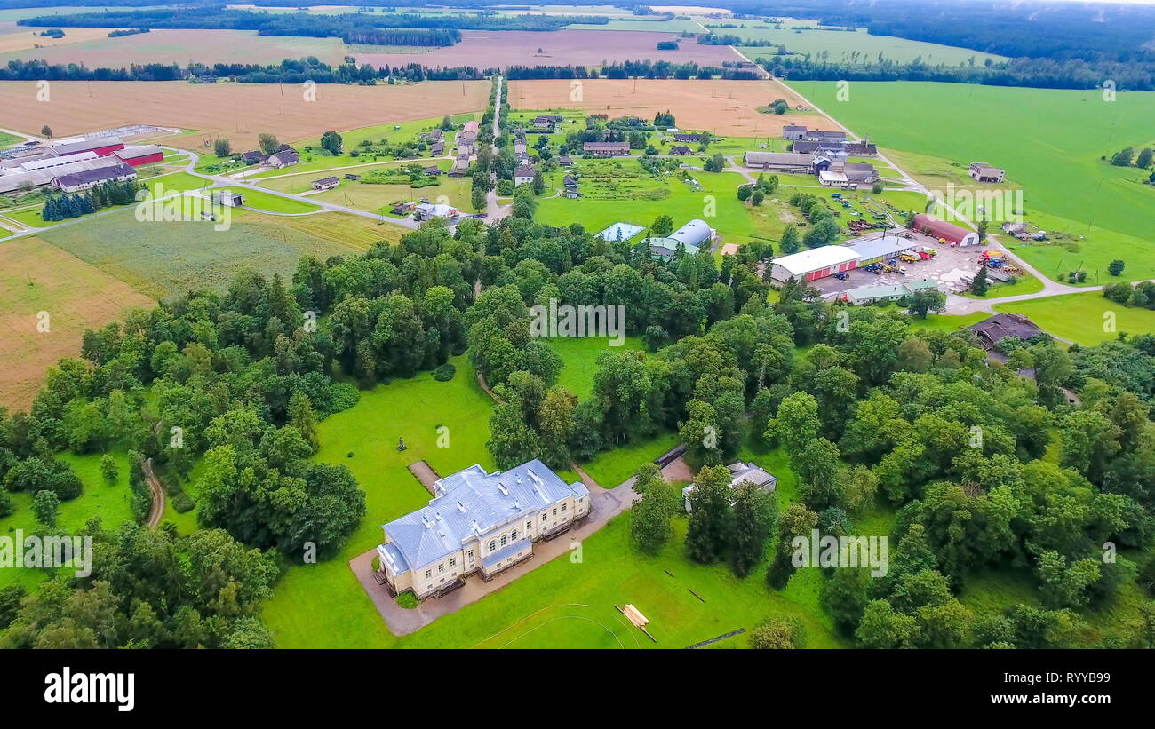 The white big manor in the town of Muuga in Estonia with trees ...