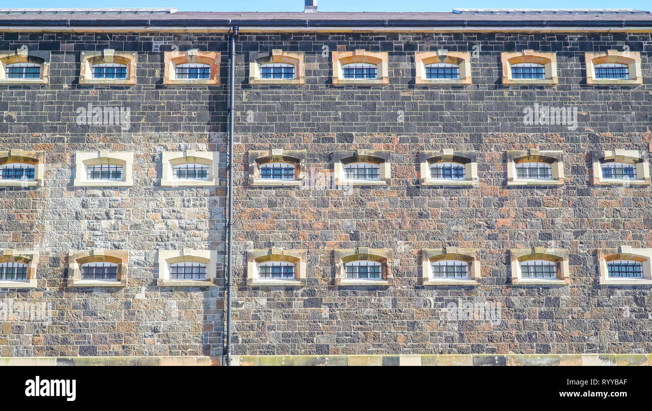 Many small windows on the jail building in Belfast city in Ireland ...