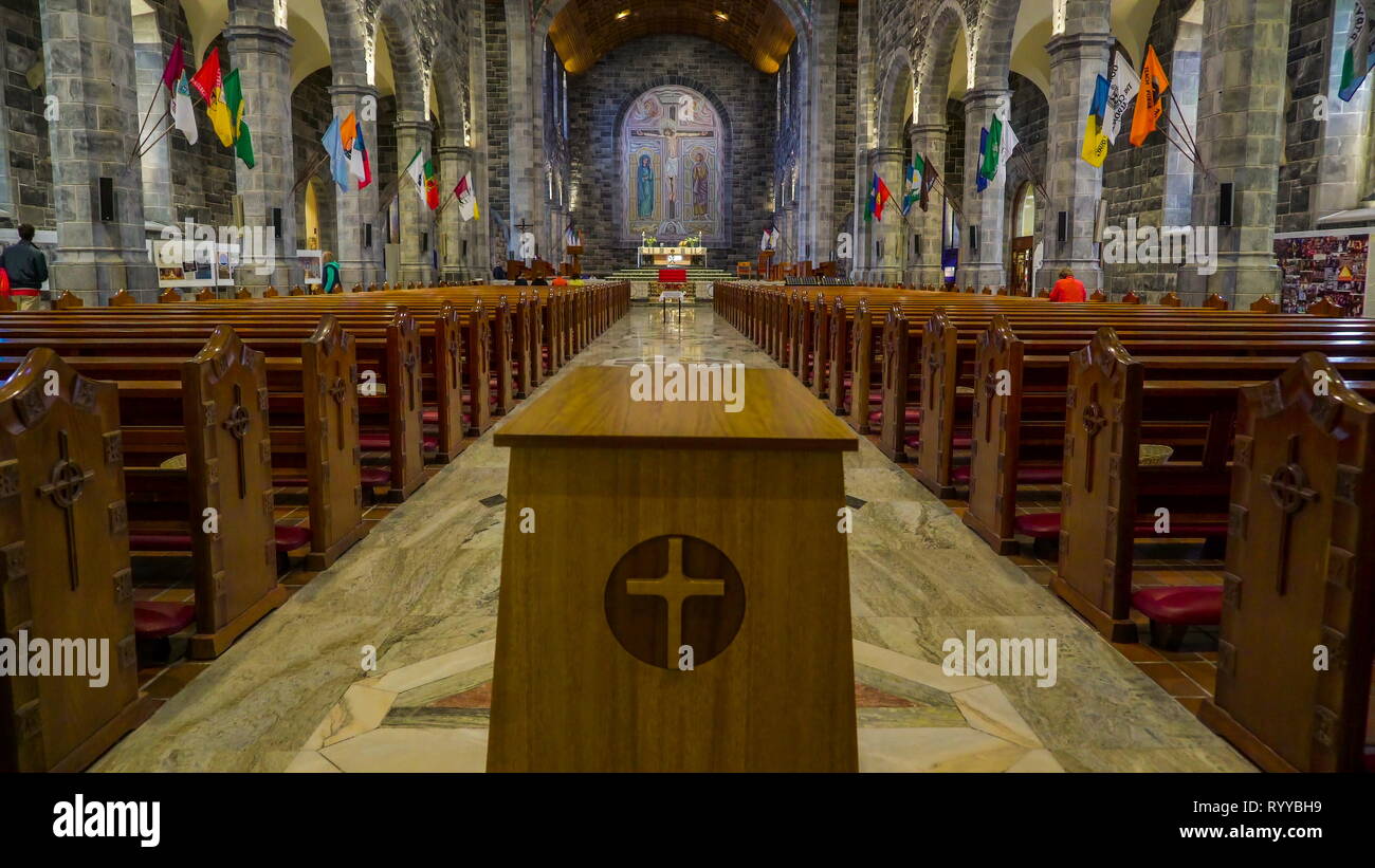 The table on the middle of the church aisle the benches inside and the ...