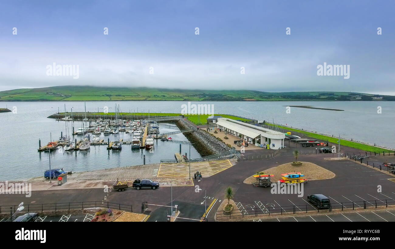 The small port in Dingle Ireland with lots of small boats and yachts ...