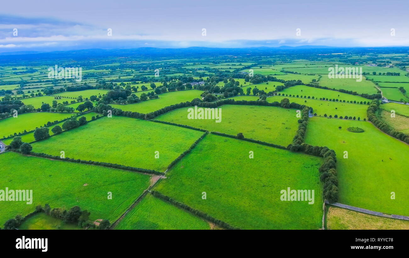 The green farm fields and the trees around in the area where the Rock ...