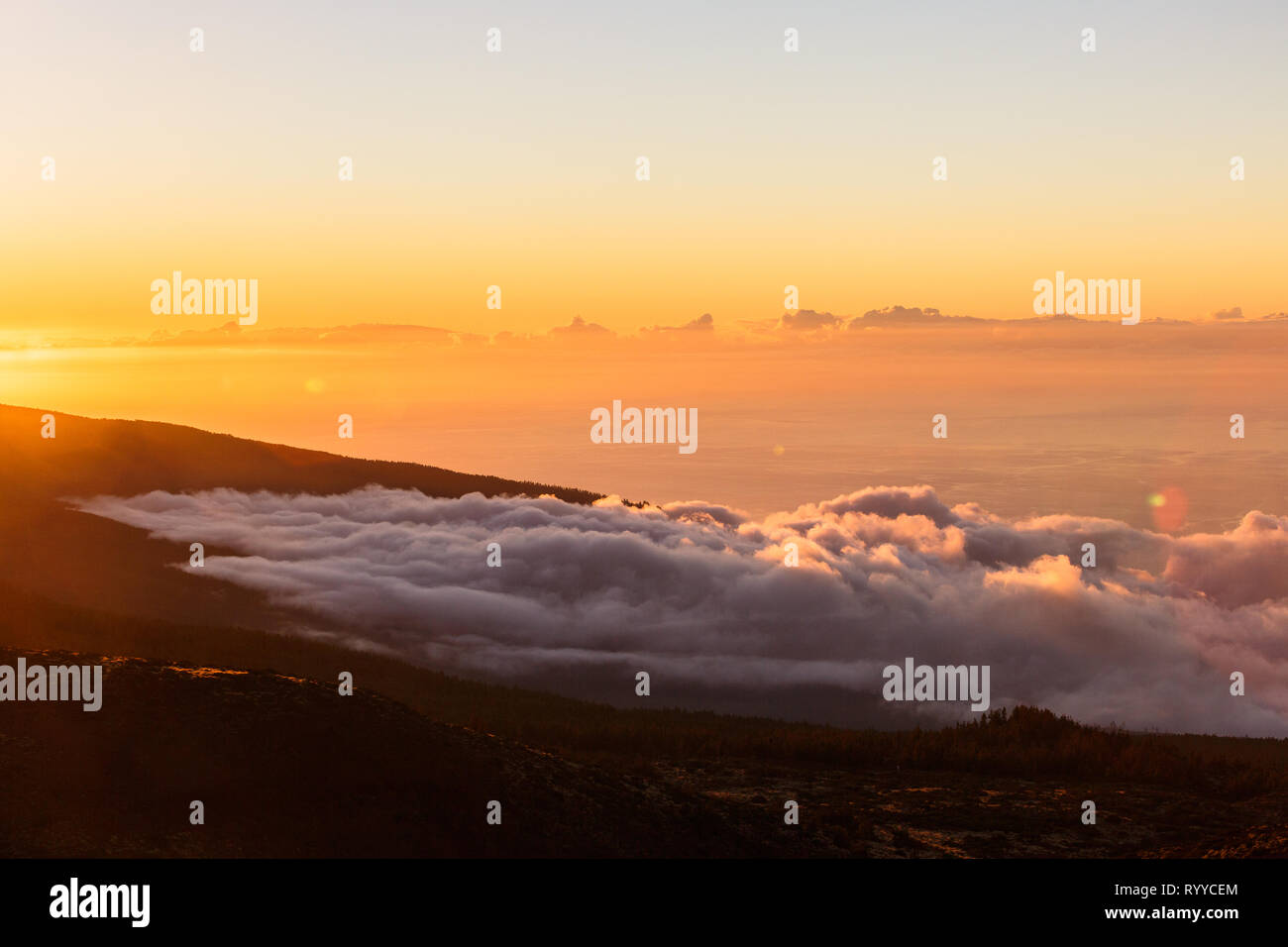 Incredible sunset landscape in the mountains. Clouds lie on the ...