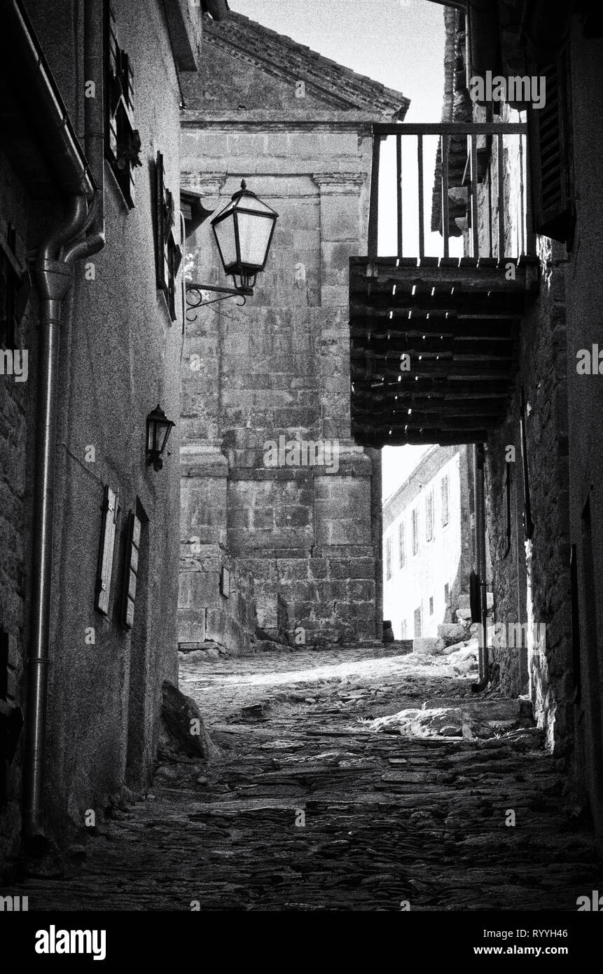 old stone street in a small Istrian town Hum, vintage black and white ...