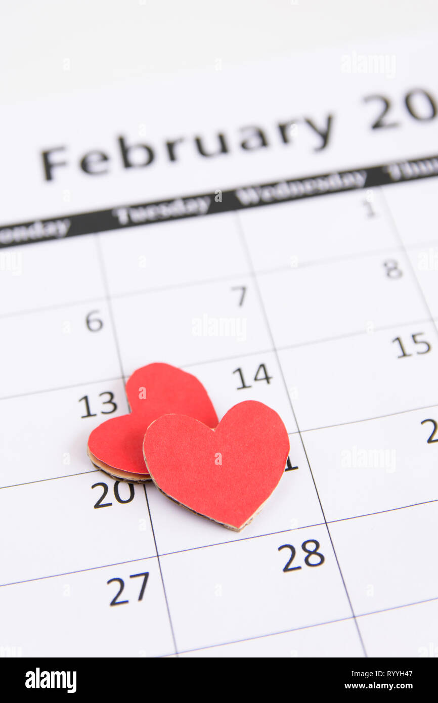 Calendar page and red hearts paper on February 14 of Valentines day ...