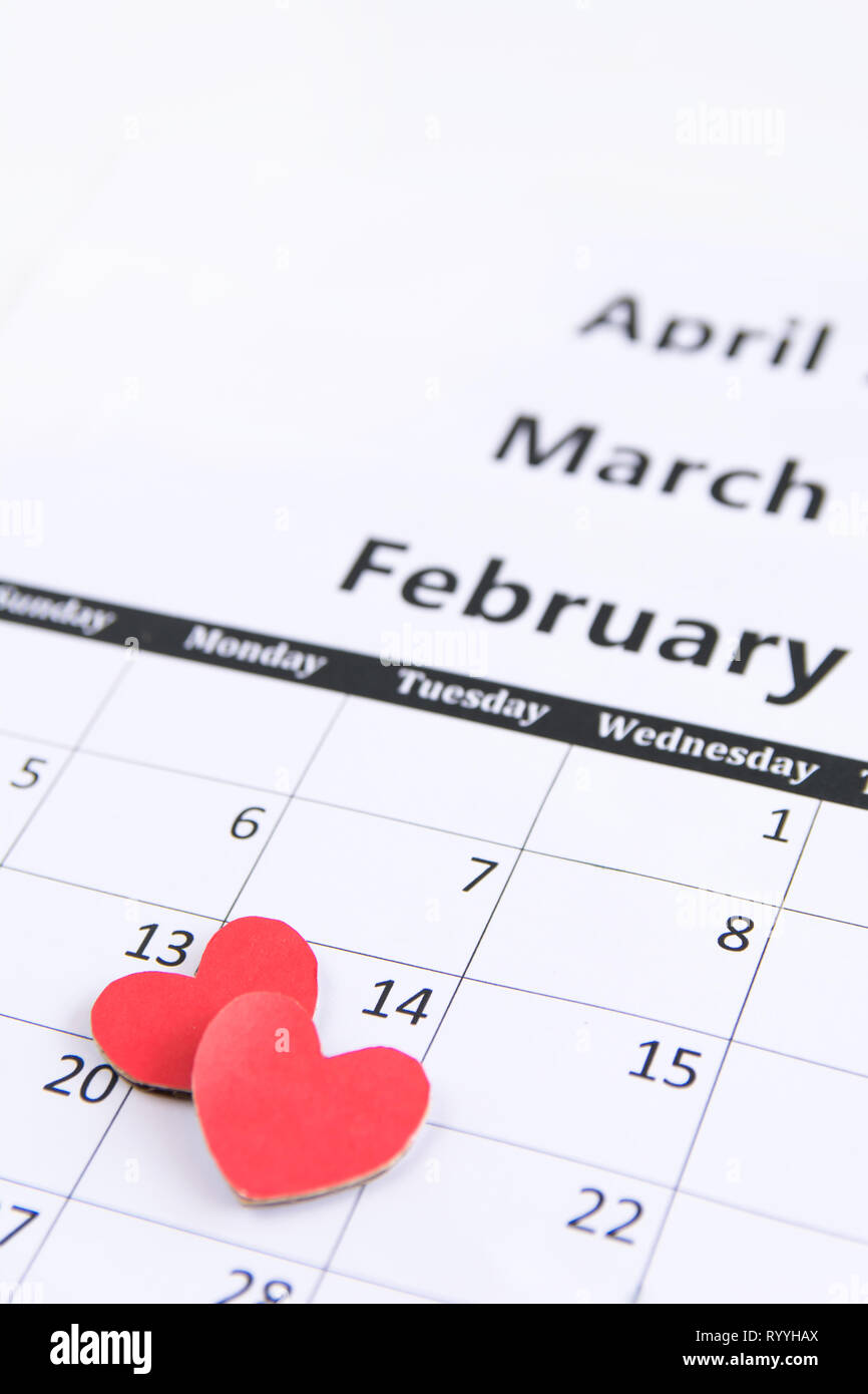 Calendar page and red hearts paper on February 14 of Valentines day ...