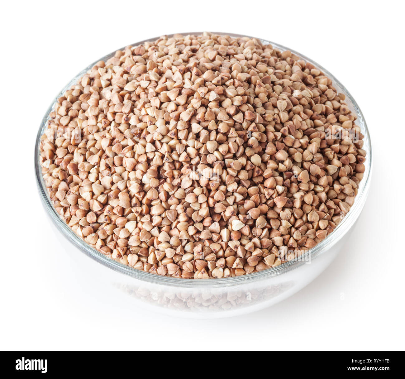 Roasted buckwheat grains in glass bowl isolated on white background ...