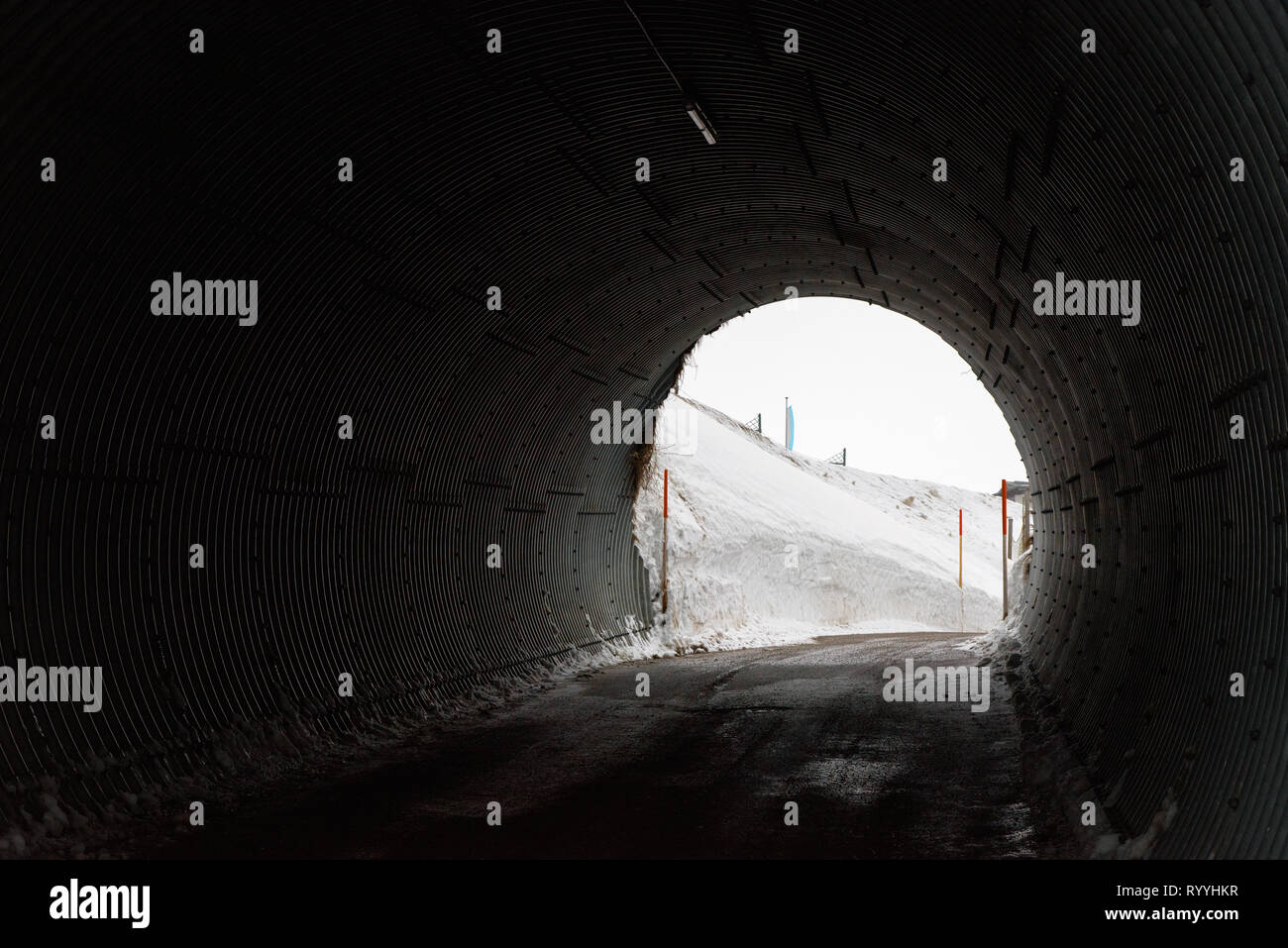 exit from the tunnel with a view of high snow along the road,winter ...