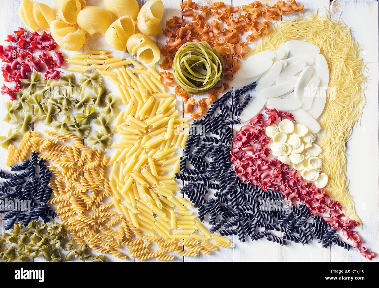 Different types of pasta forming swirls Stock Photo - Alamy