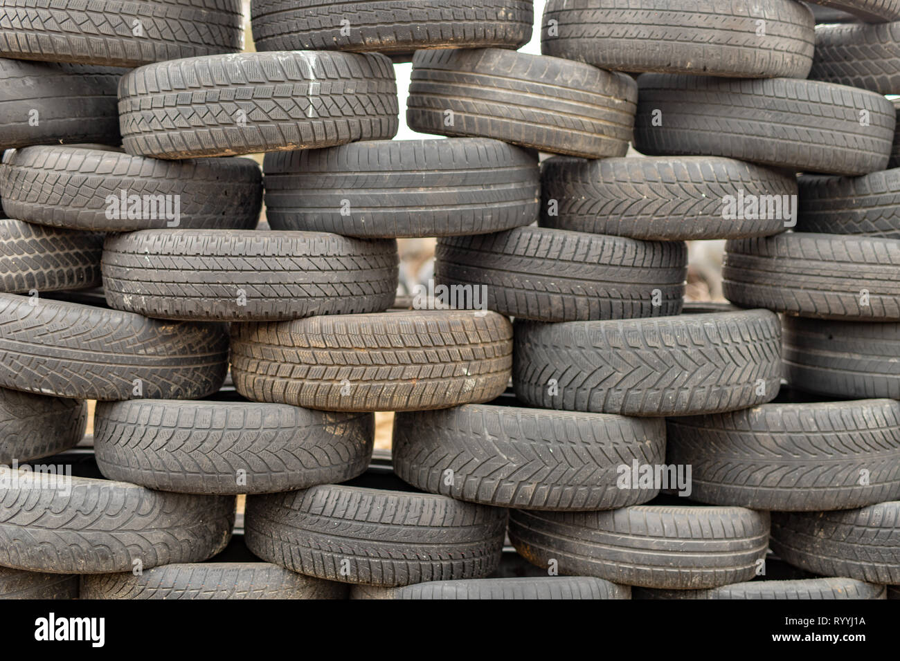 Old worn out tires on an abandoned trash dump. Garbage heap ready for ...