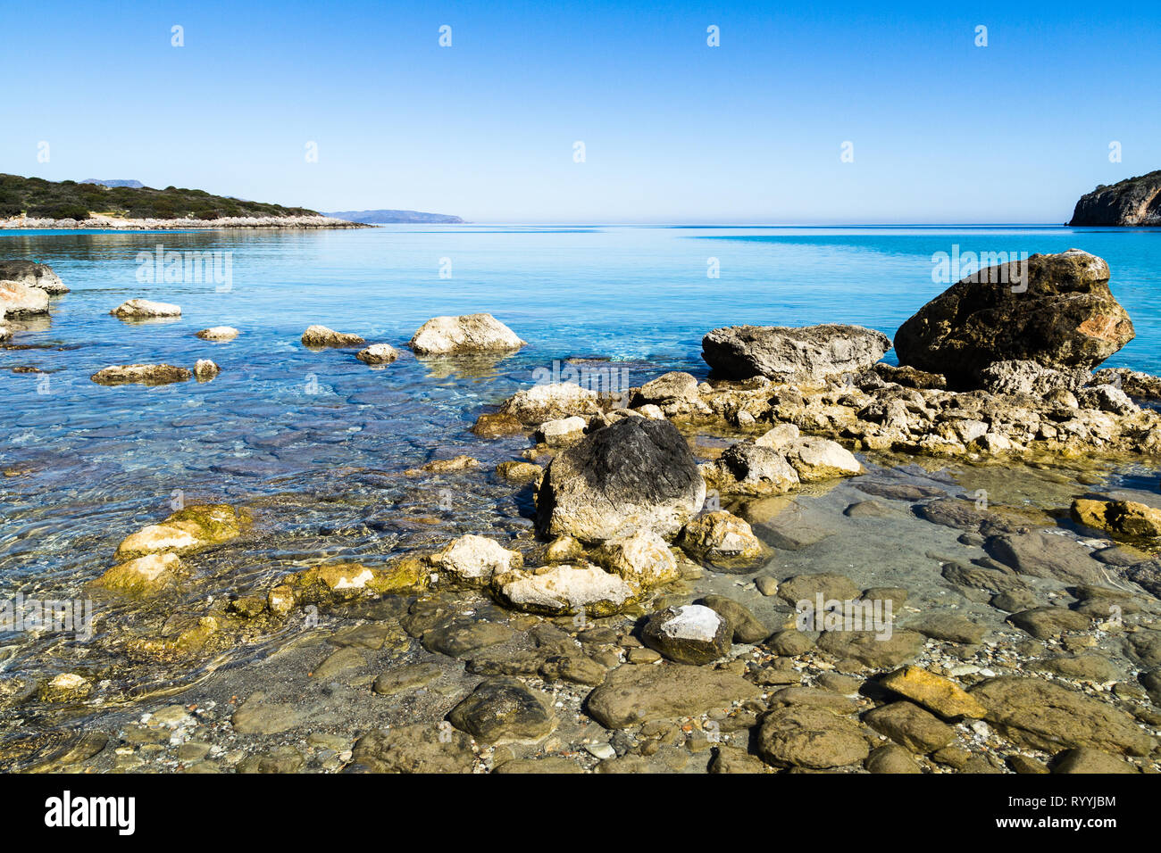 Beautiful crystal clear turquoise waters coast with small pebble stones ...