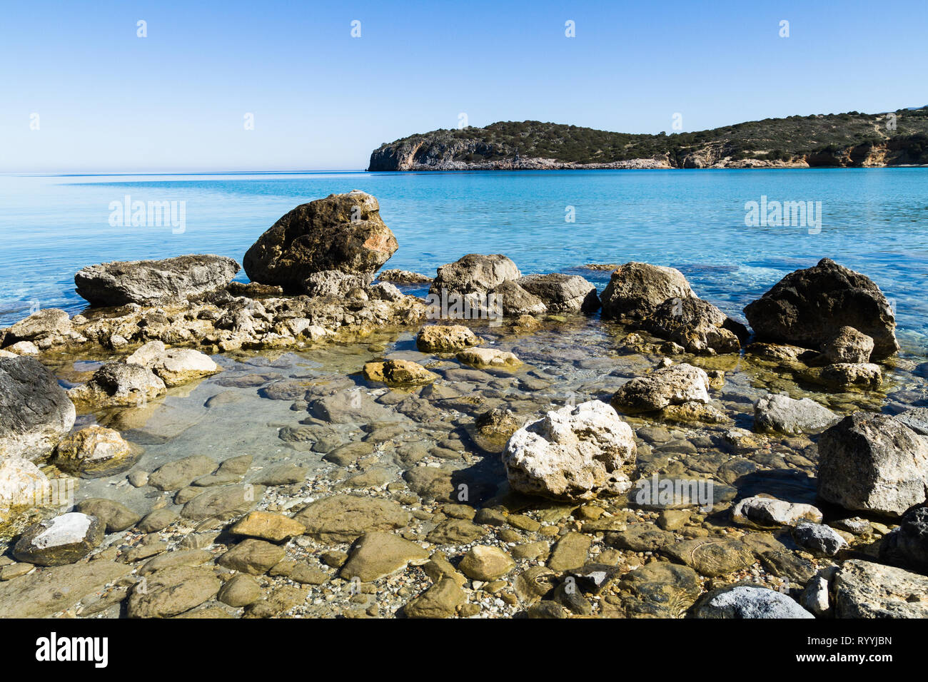 Beautiful crystal clear turquoise waters coast with small pebble stones ...