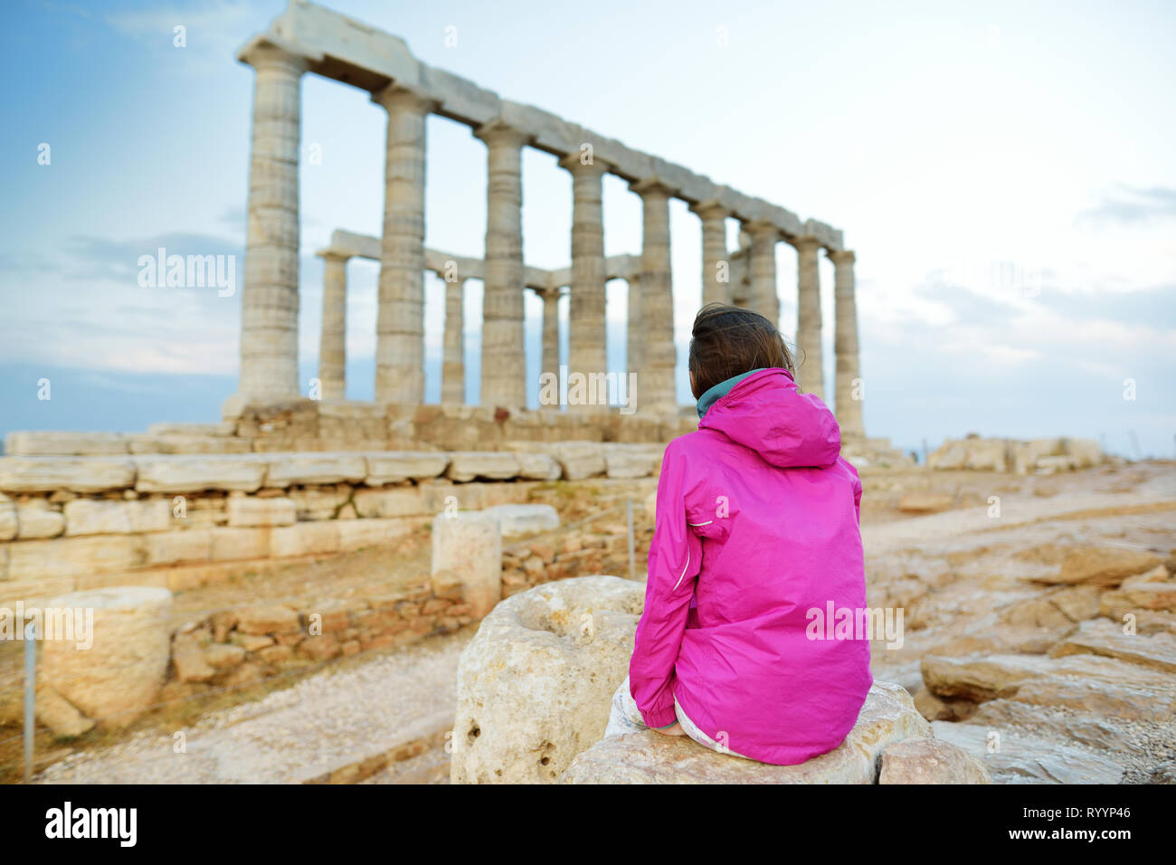 Cute young girl exploring the Ancient Greek temple of Poseidon at Cape ...