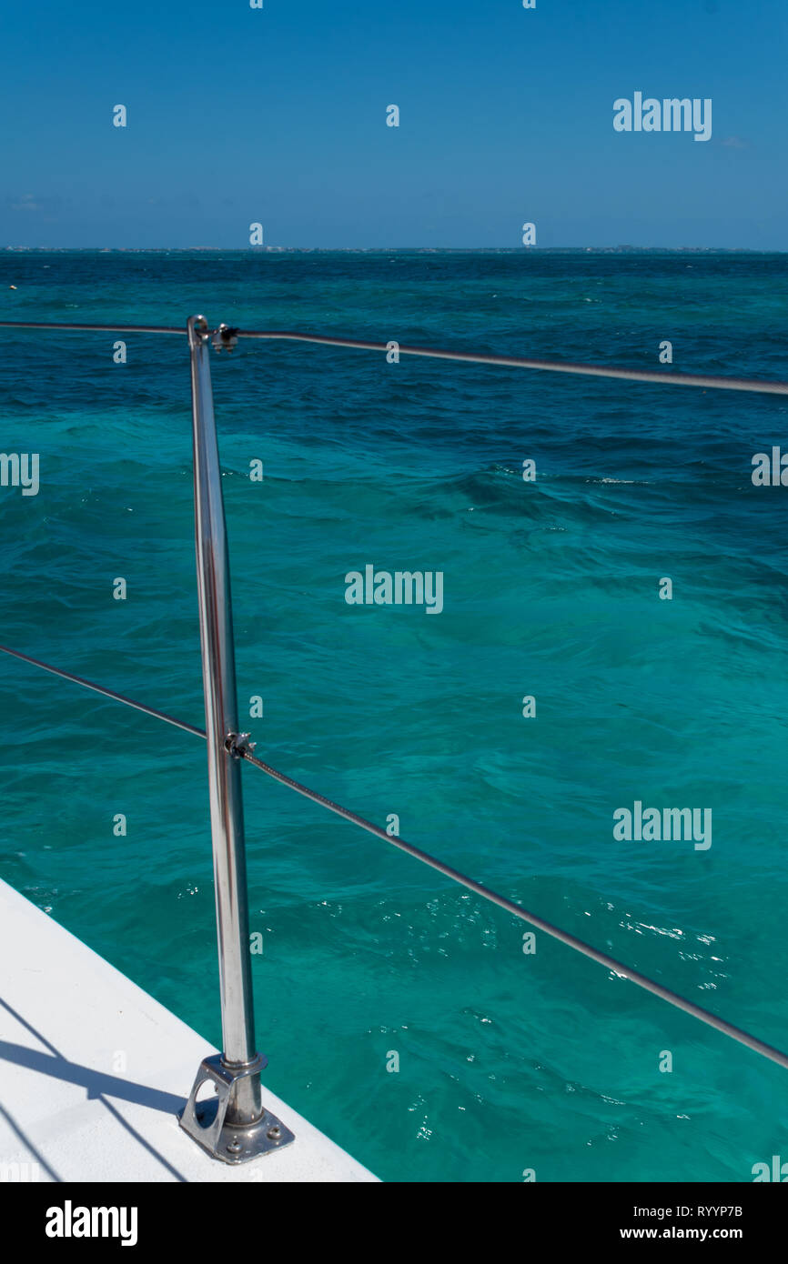 sailboat handrail in the caribbean. metal handrail against crystal ...
