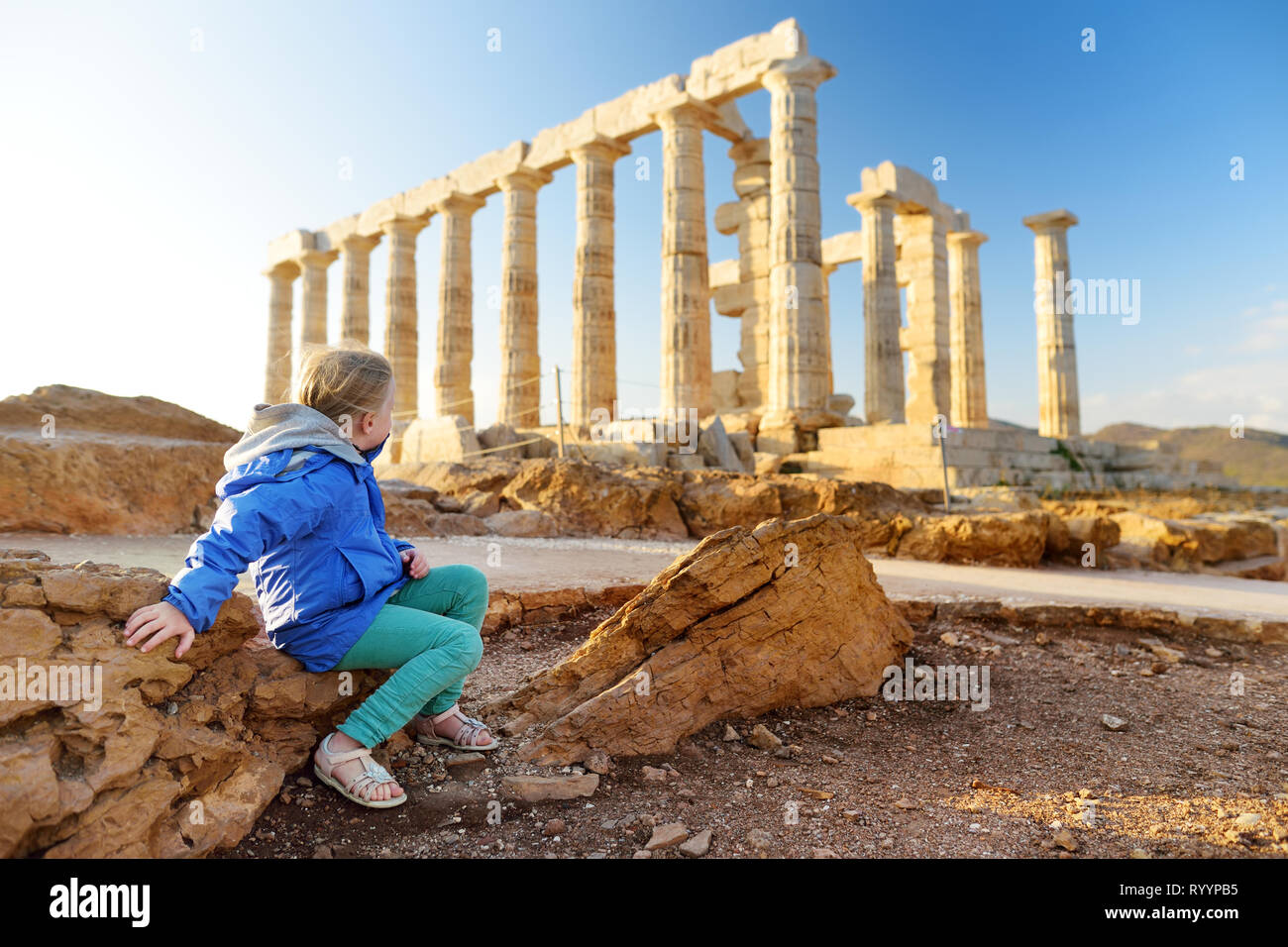 Cute young girl exploring the Ancient Greek temple of Poseidon at Cape ...