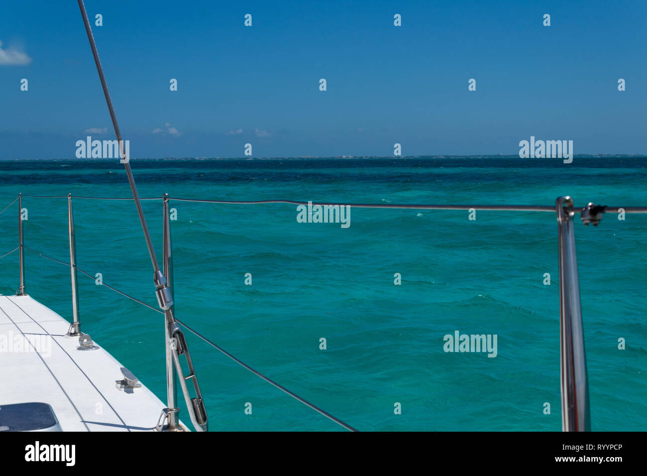 sailboat handrail in the caribbean. metal handrail against crystal ...