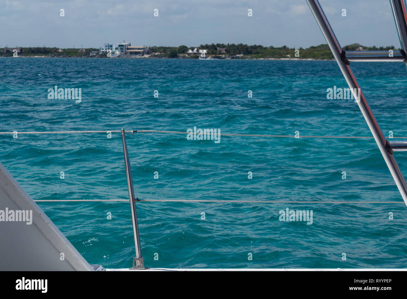 sailboat handrail in the caribbean. metal handrail against crystal ...