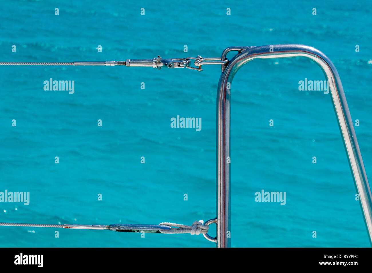 sailboat handrail in the caribbean. metal handrail against crystal ...
