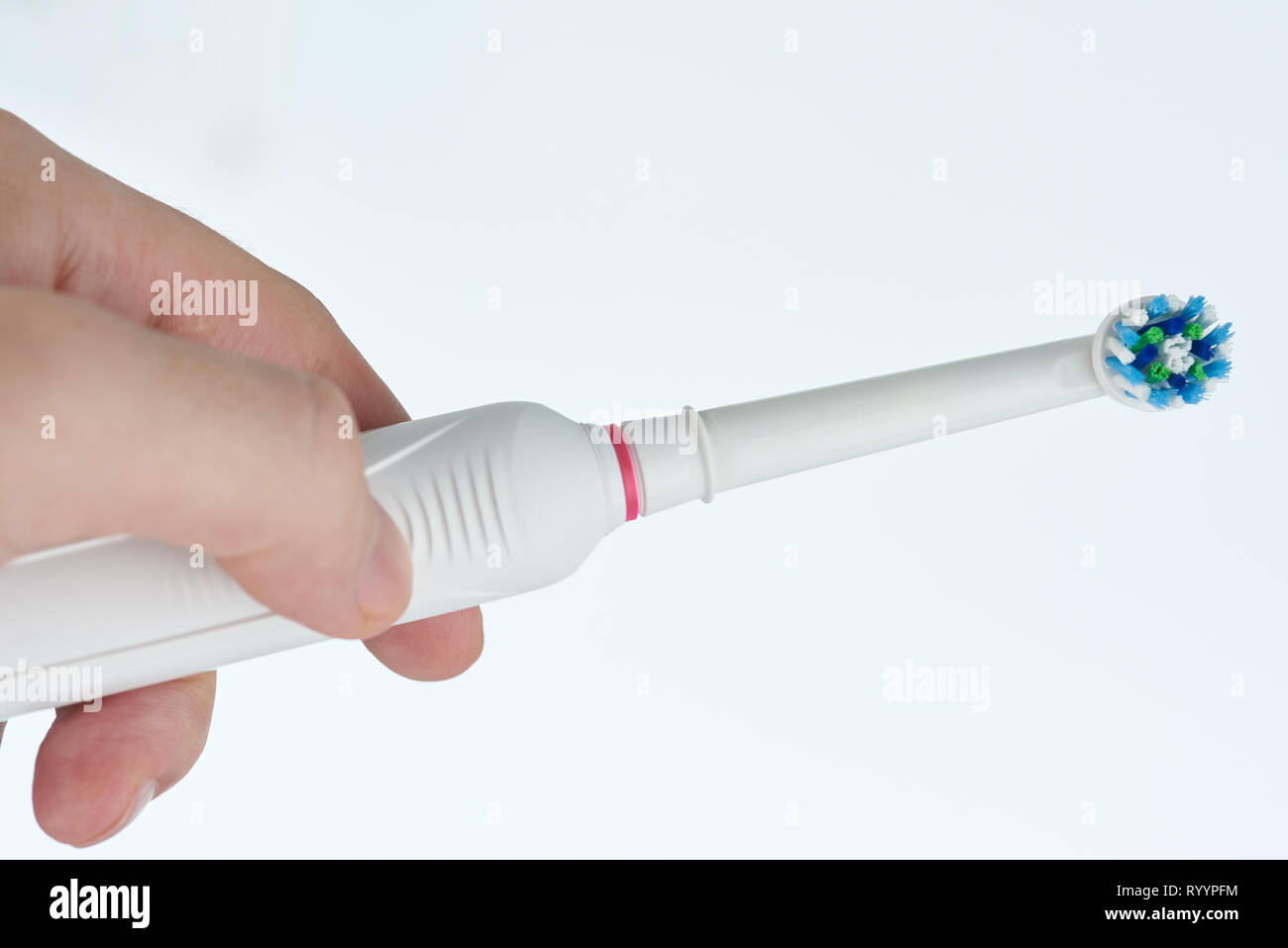 Electronic toothbrush in hand close up view isolated on white ...