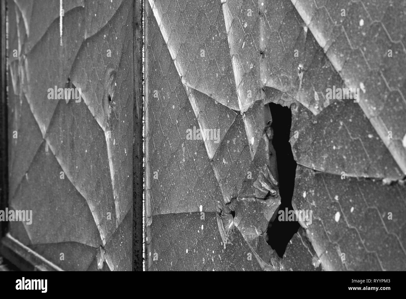 Black and white image of a broken warehouse window Stock Photo - Alamy