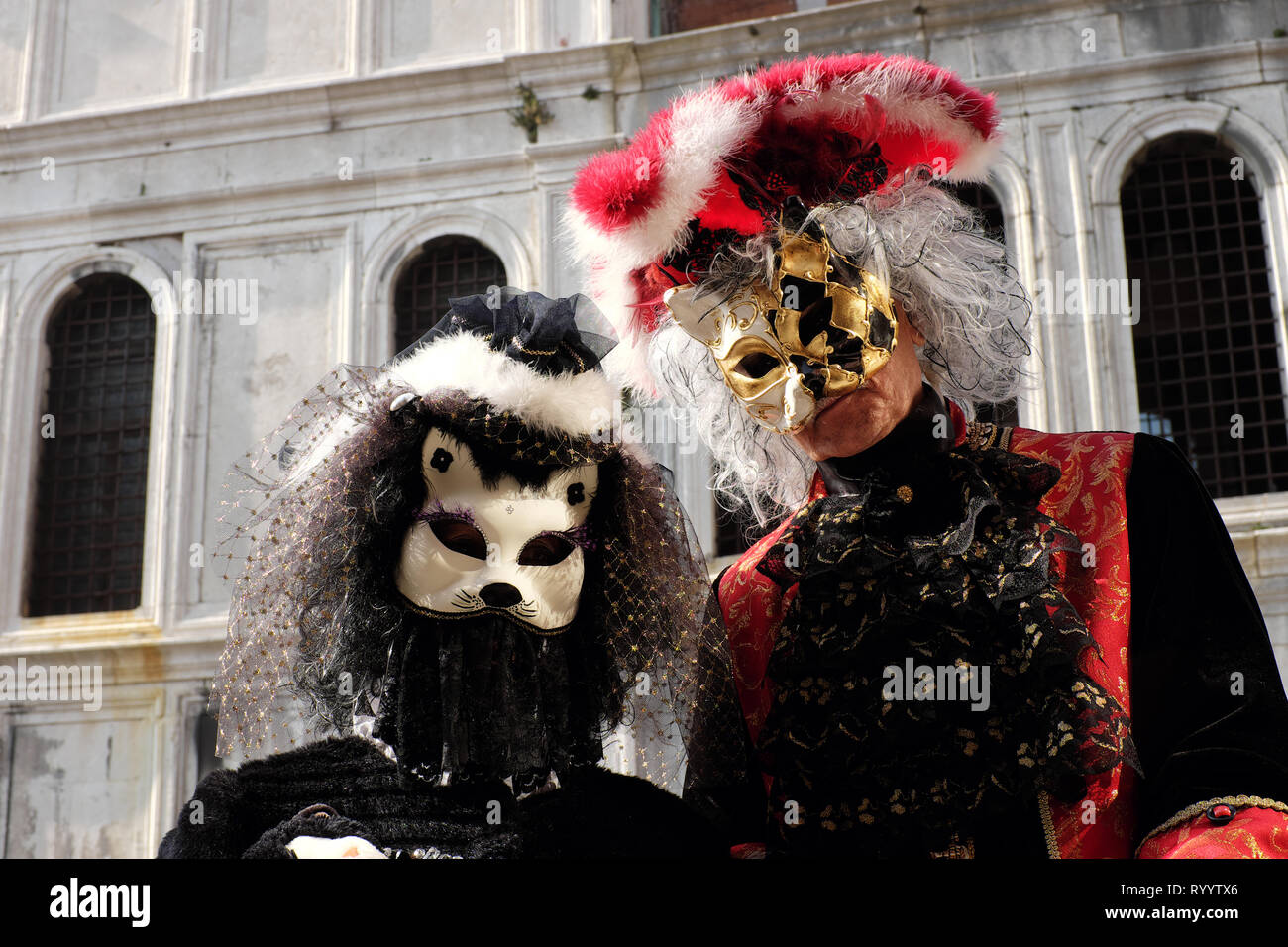 People dressed in traditional mask and costume for Venice Carnival ...