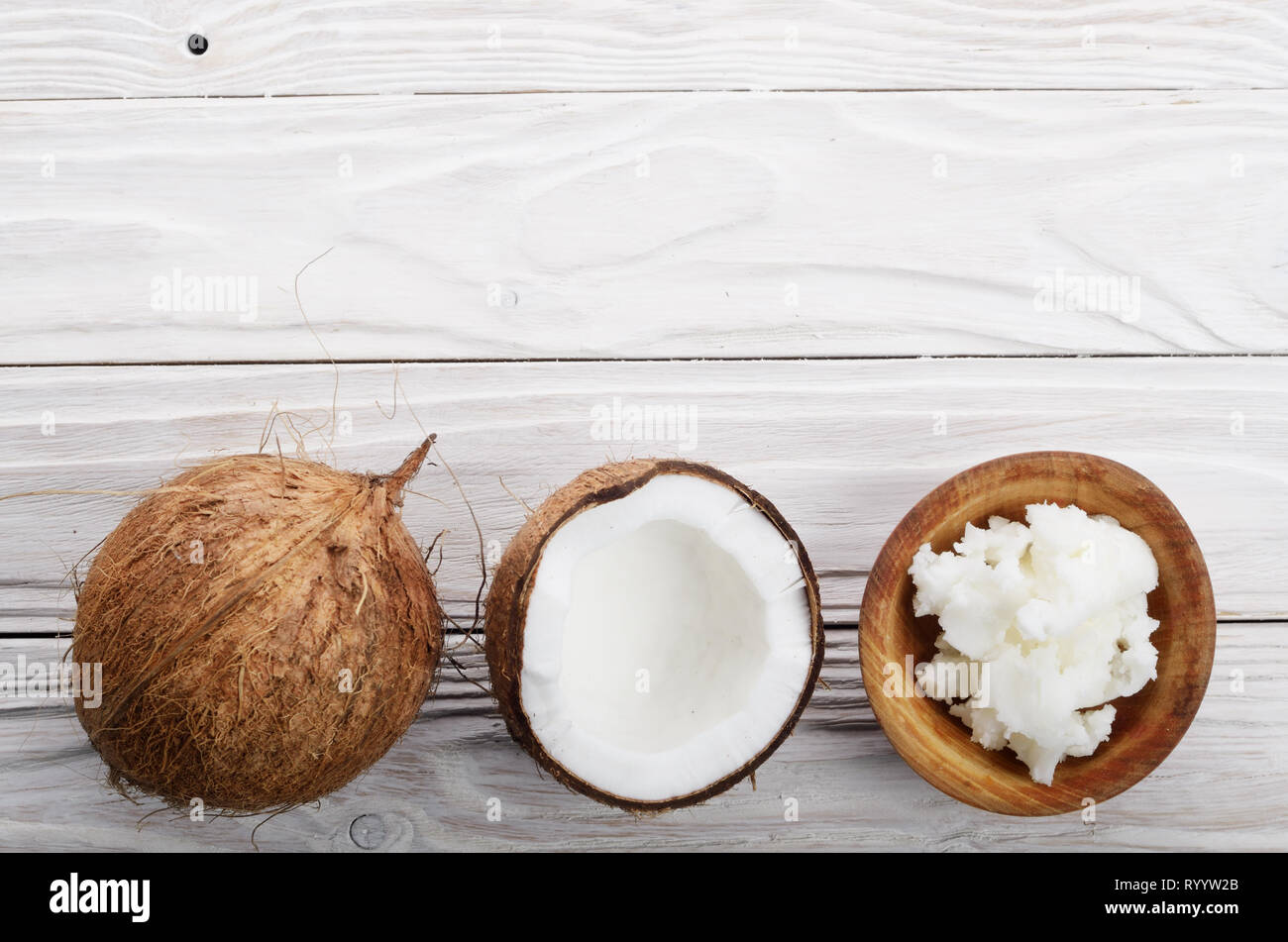 Flat lay background of coconut, coconut shell, hard oil in wooden bowl ...