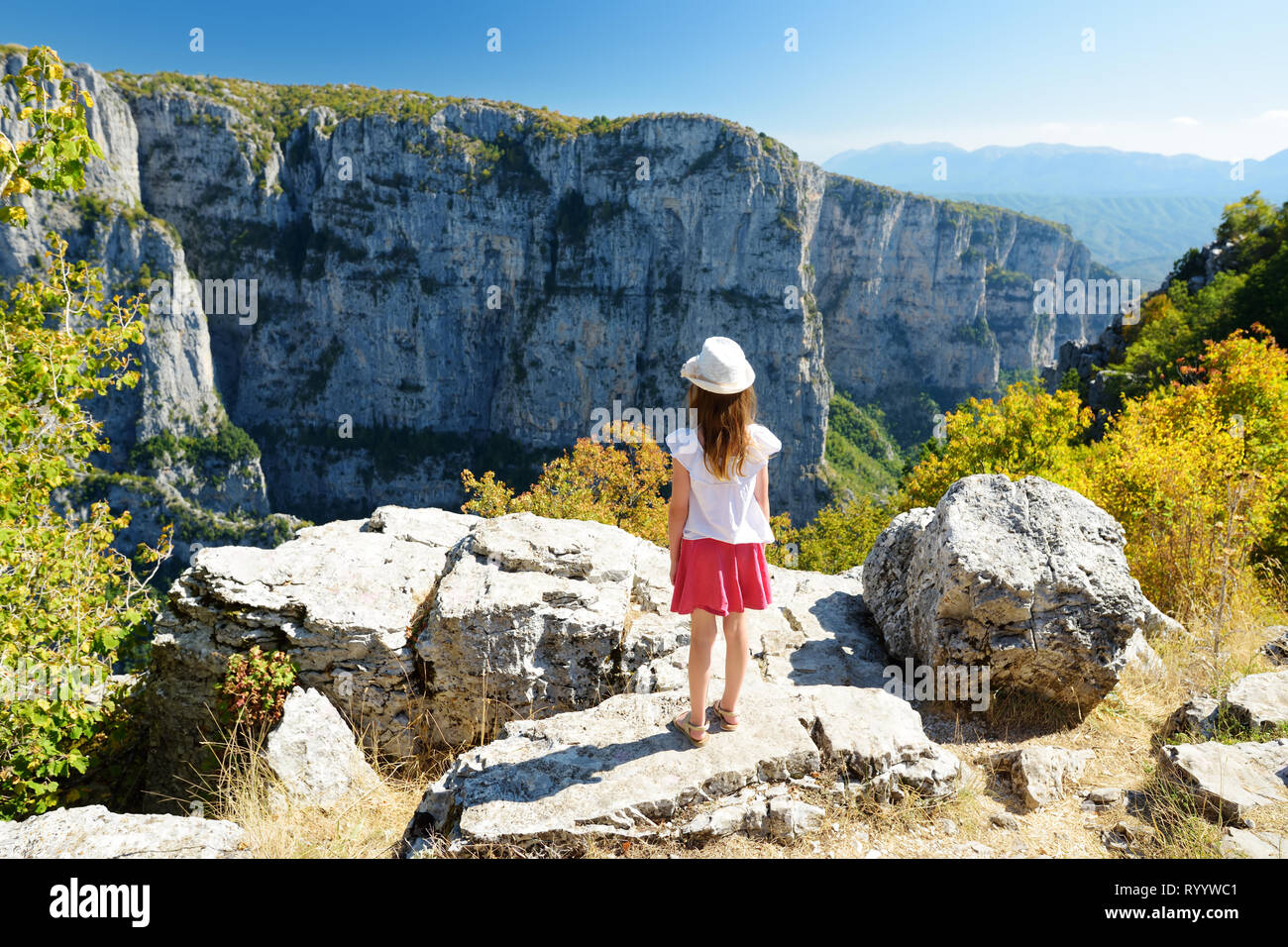 Cute young girl exploring Vikos Gorge, a gorge in the Pindus Mountains ...