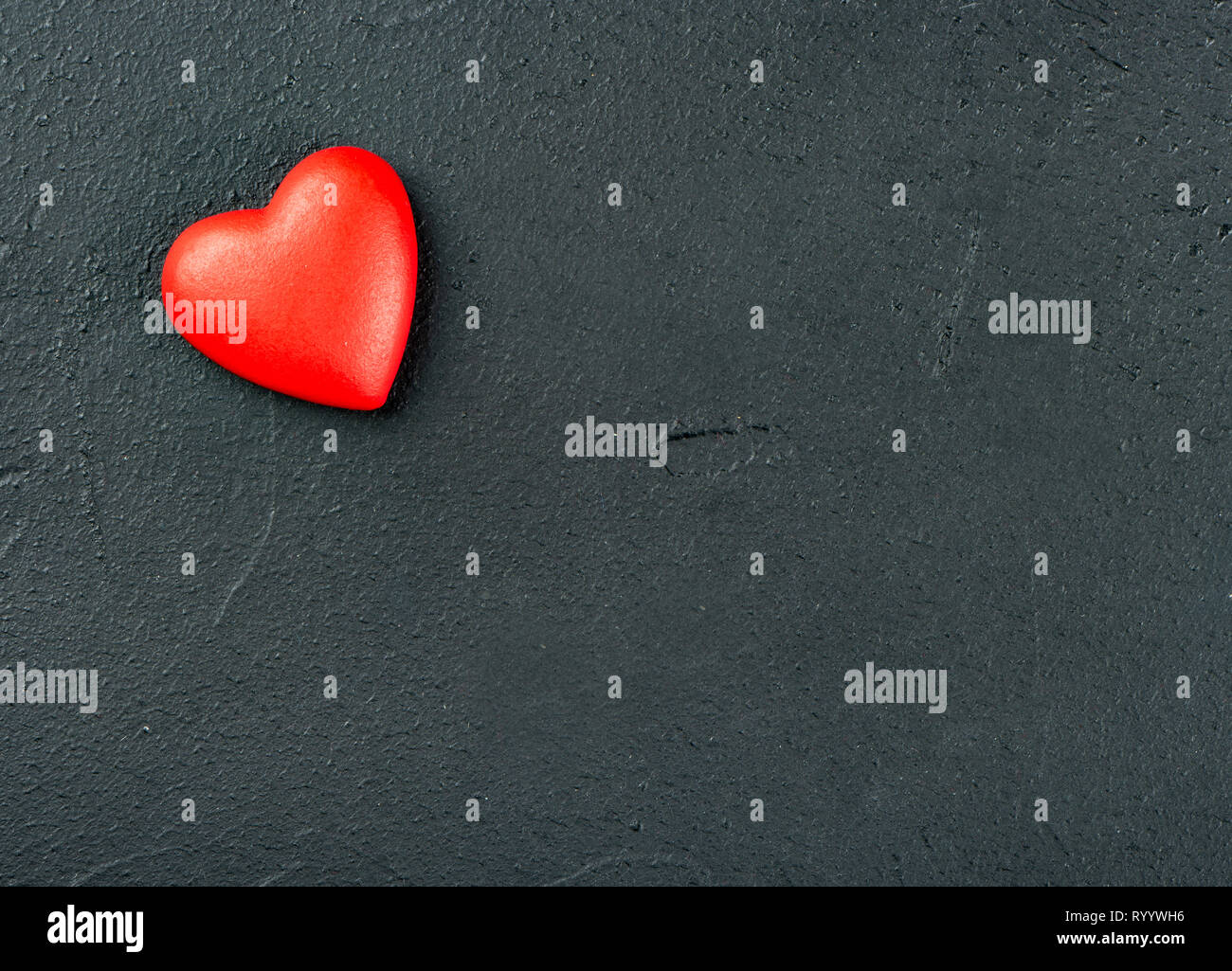 One red plastic heart on an empty concrete background, top view Stock ...