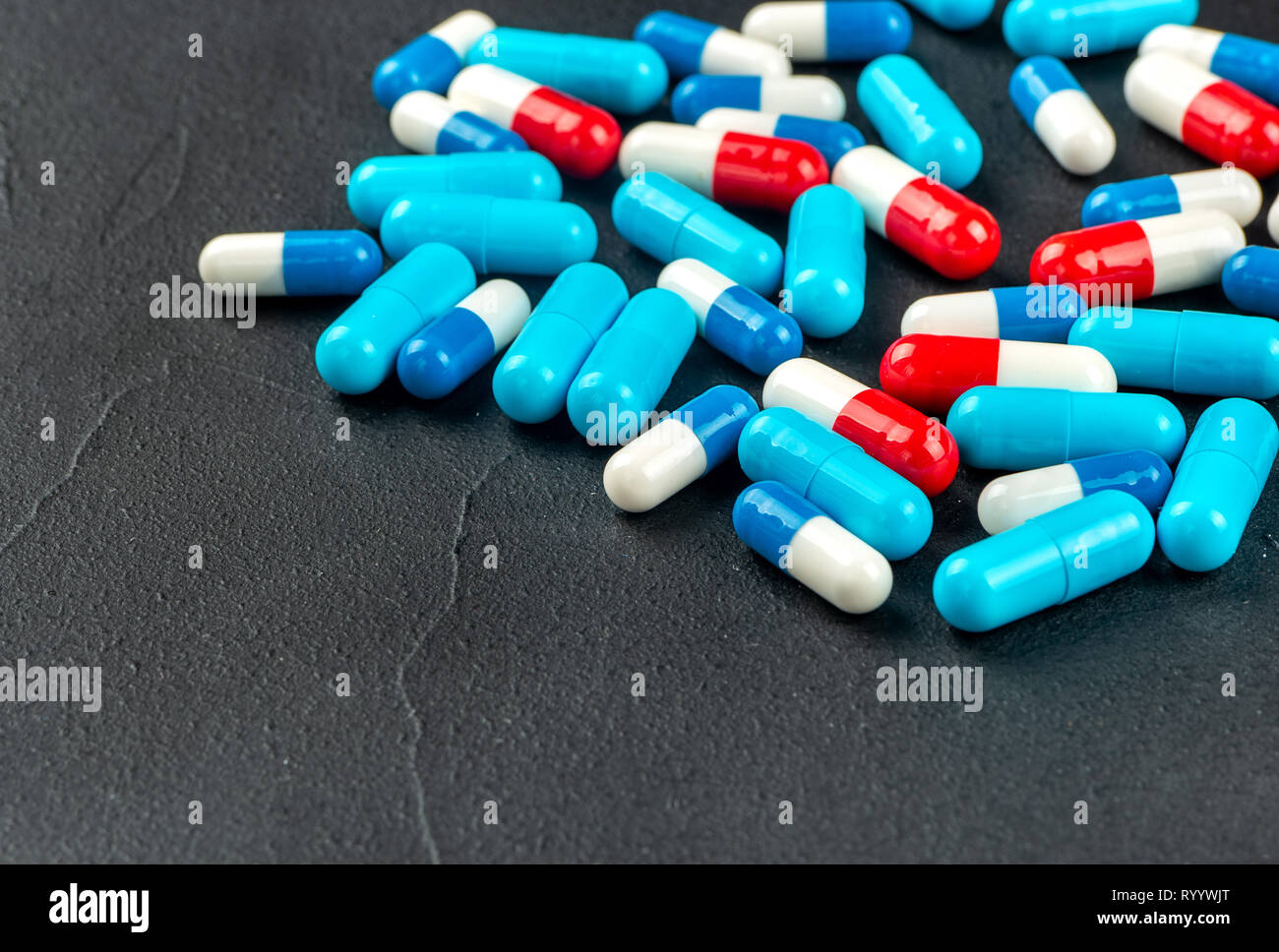 Scattered multicolored capsules closeup on a concrete background Stock ...