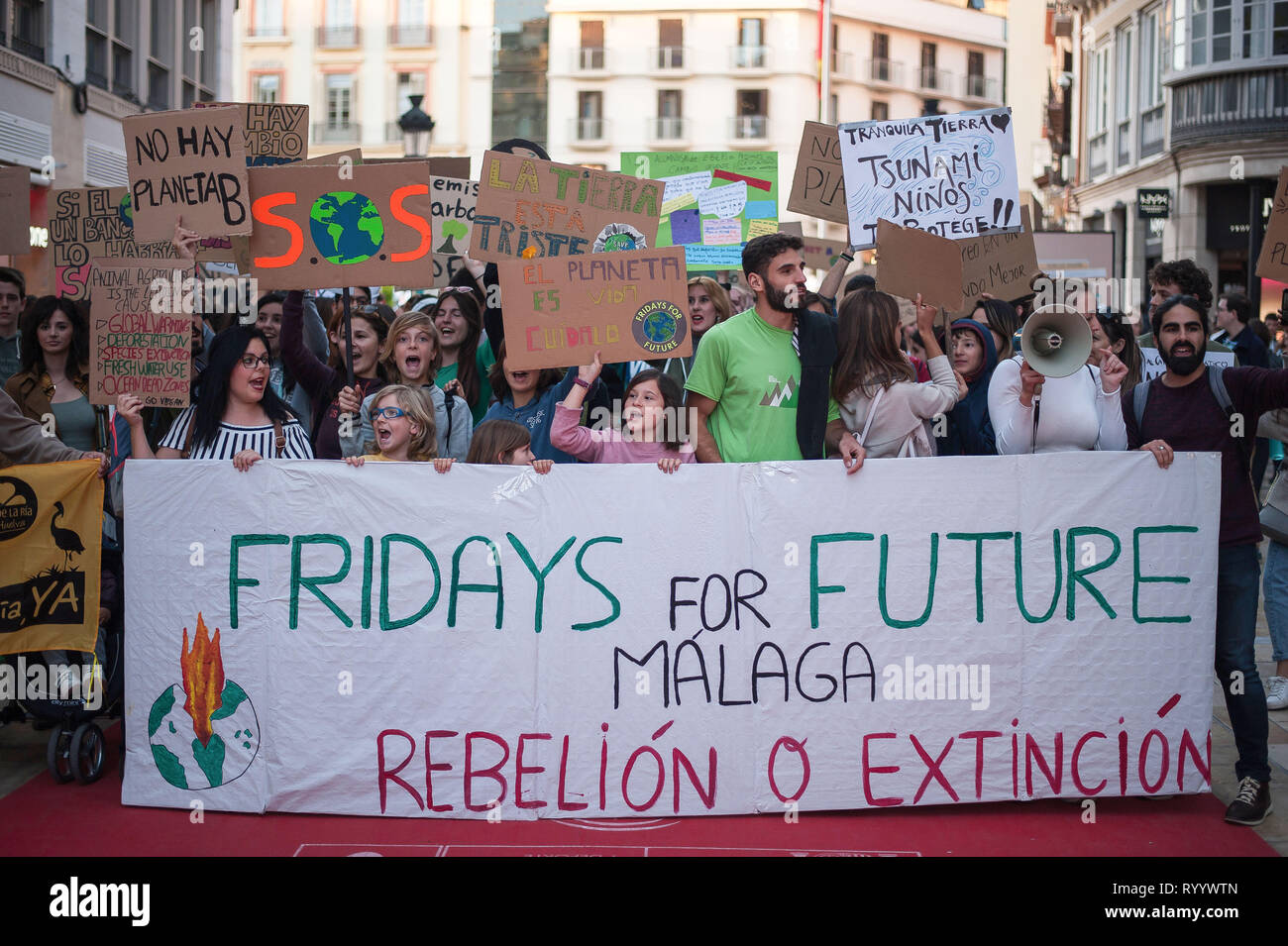 Protesters are seen holding placards and a banner during the ...