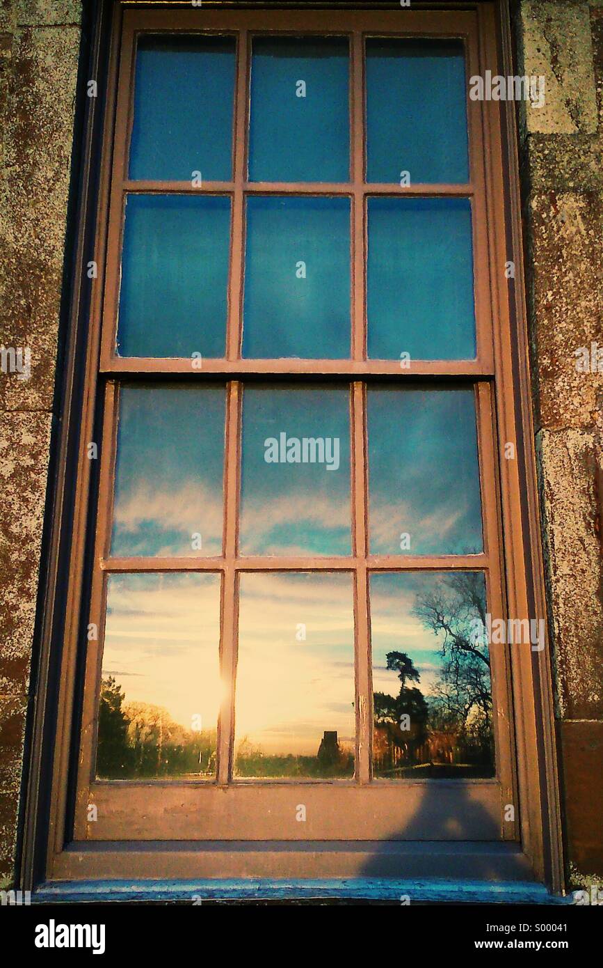 Sunset reflected in window Stock Photo - Alamy