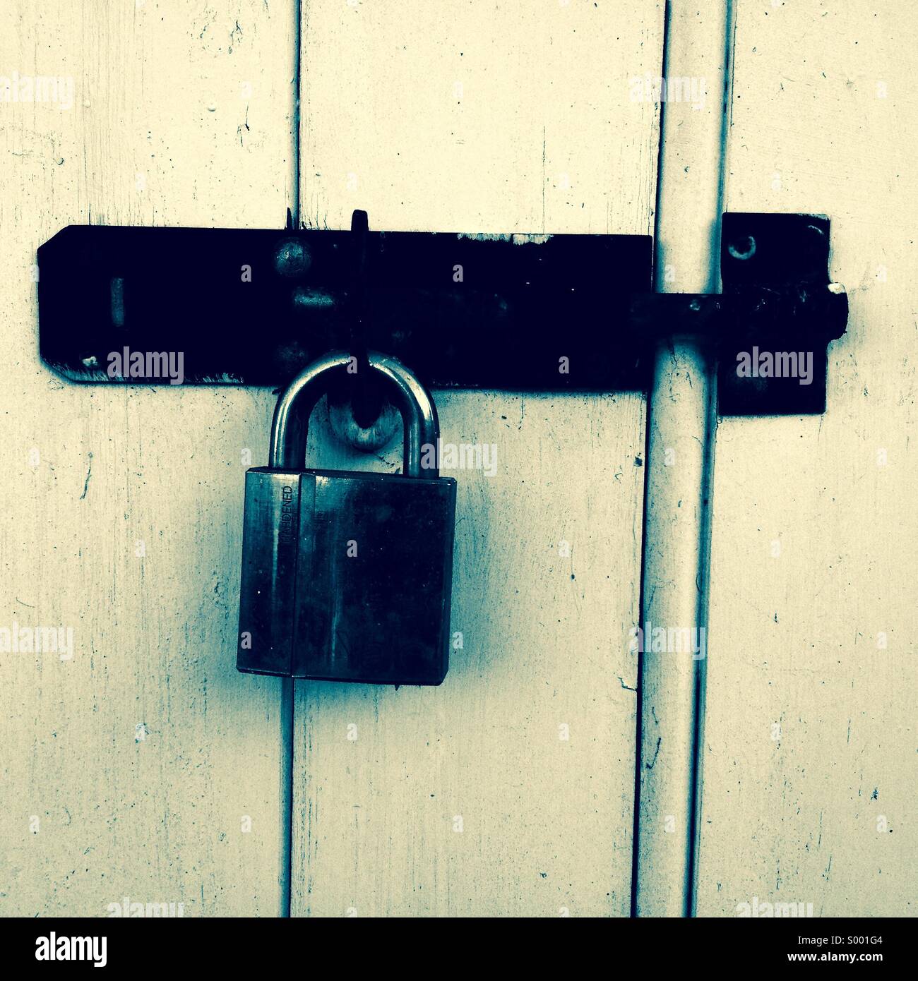 Padlock on old wooden door Stock Photo - Alamy