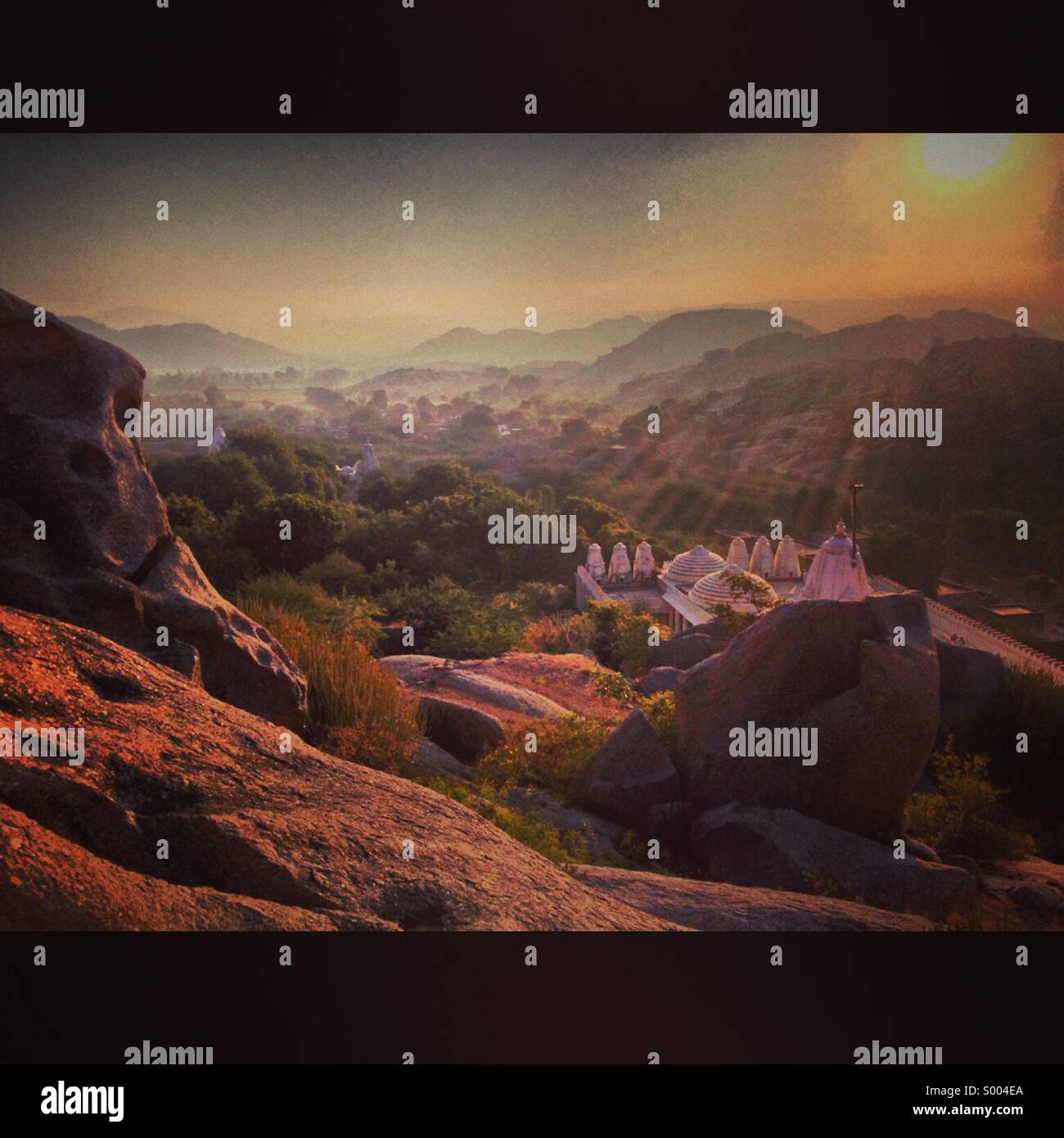 Sunrise over Indian village with temple Stock Photo - Alamy