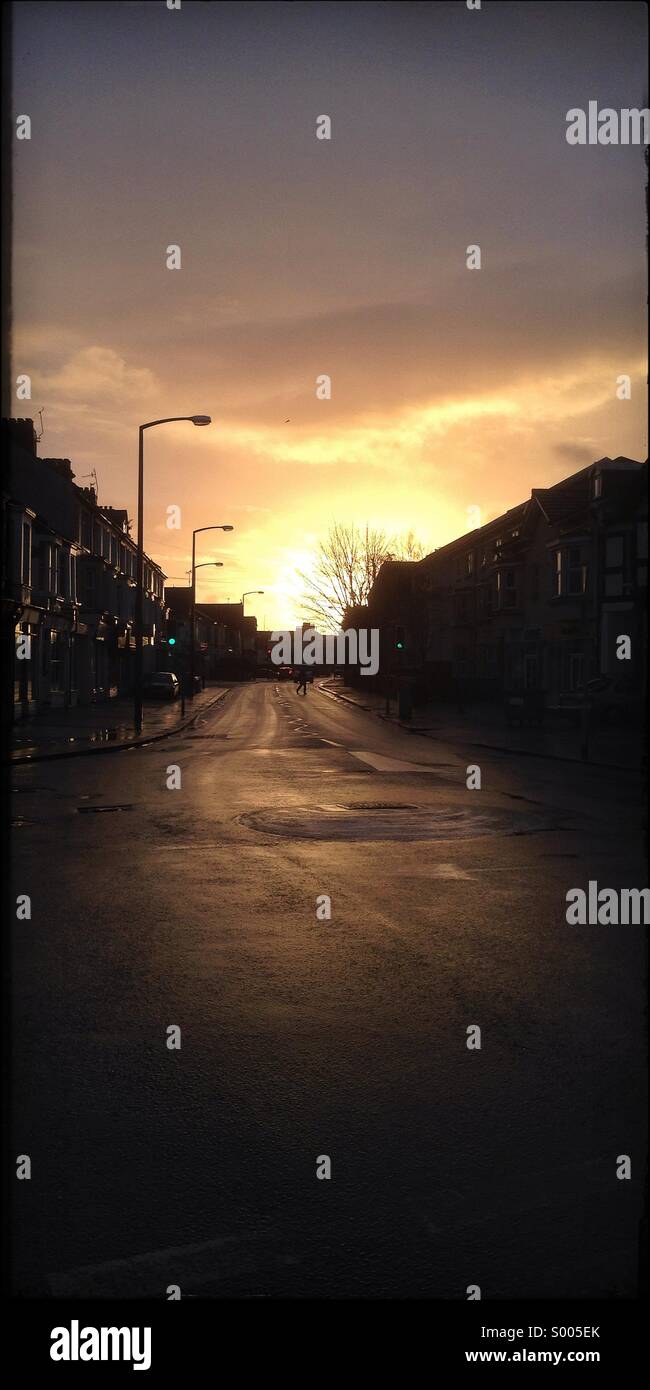 A sunrise over a damp street and mini roundabout in Worthing Stock ...