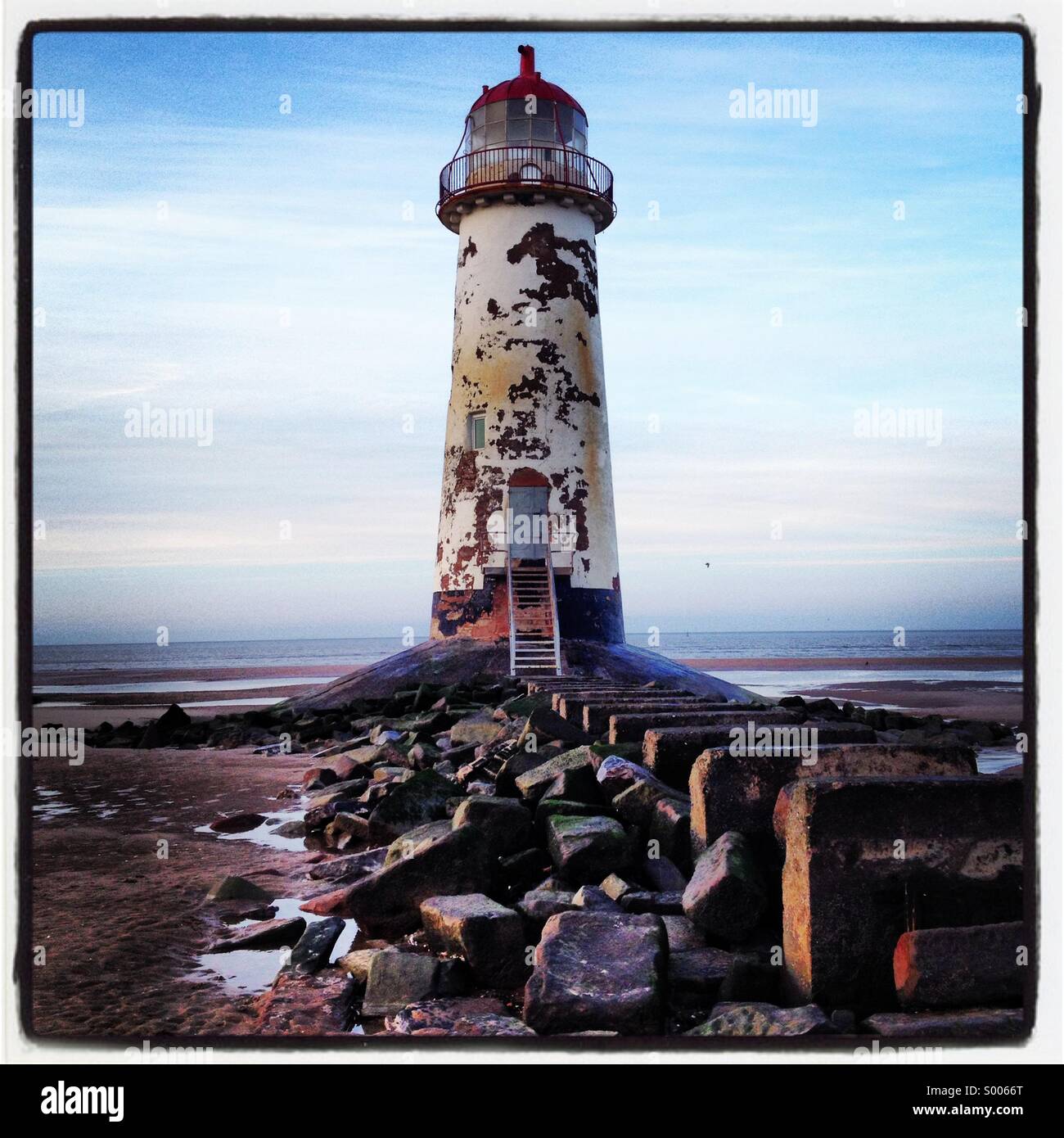 Lighthouse on the beach with the tide out Stock Photo - Alamy
