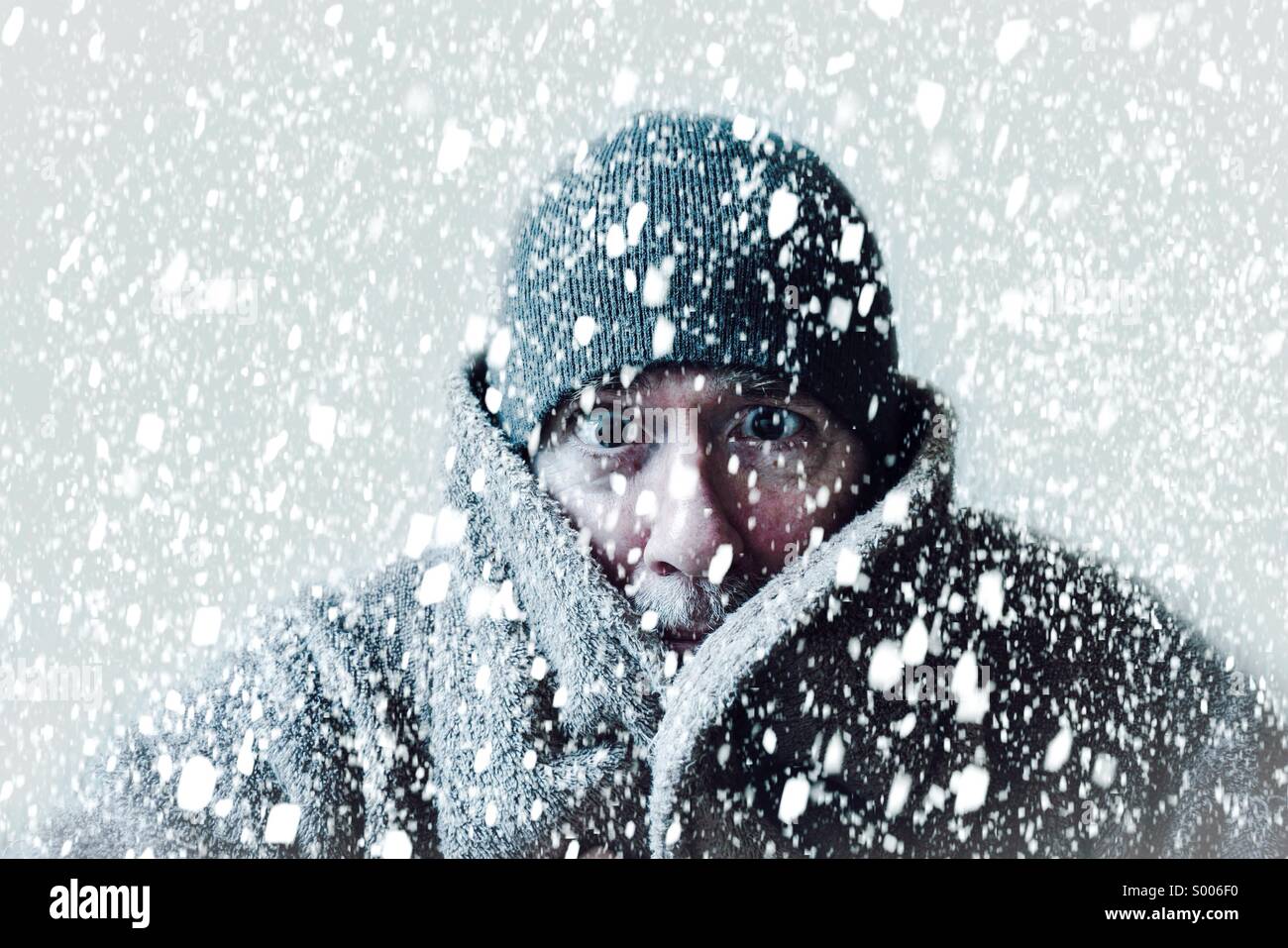Shivering man in snow storm Stock Photo - Alamy