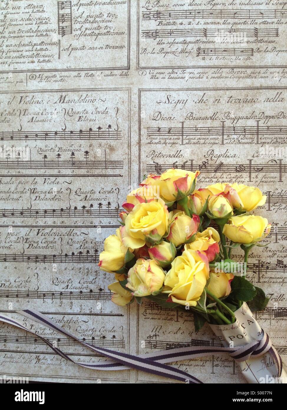Yellow rose bouquet on music background Stock Photo - Alamy