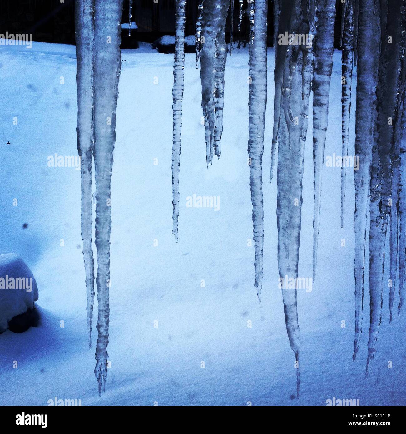 A snowy landscape with large icicles Stock Photo - Alamy